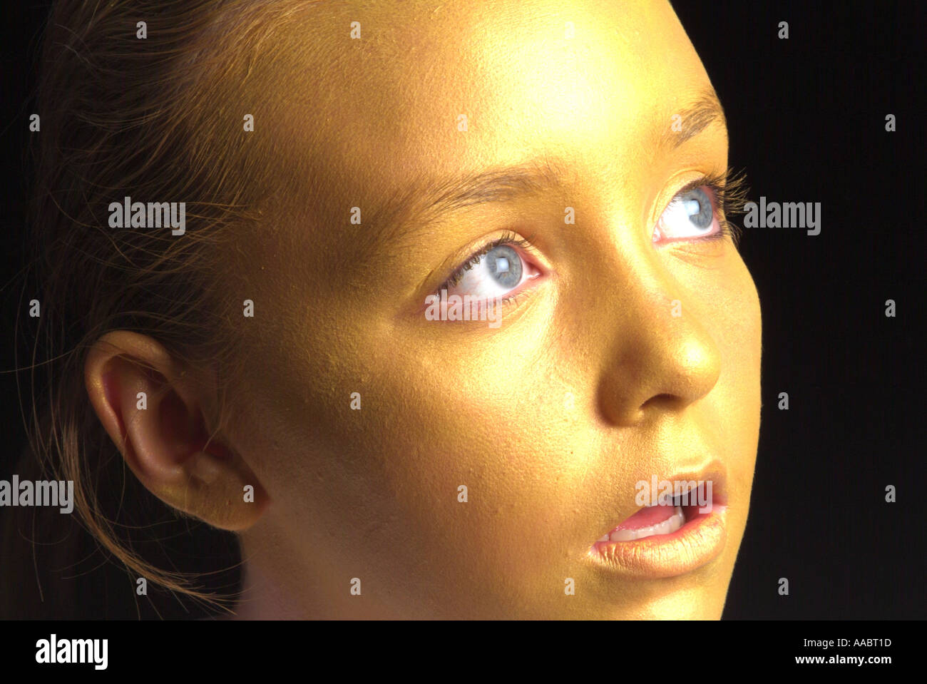 gold face girl Stock Photo - Alamy