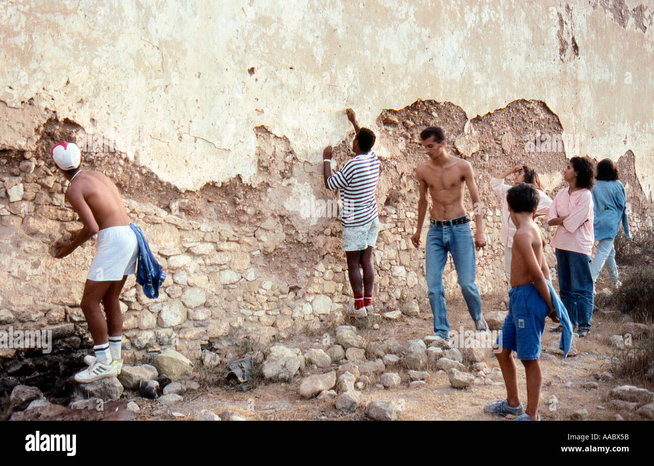 Group of youg people from Agadir writing their name on the rock Agadir ...