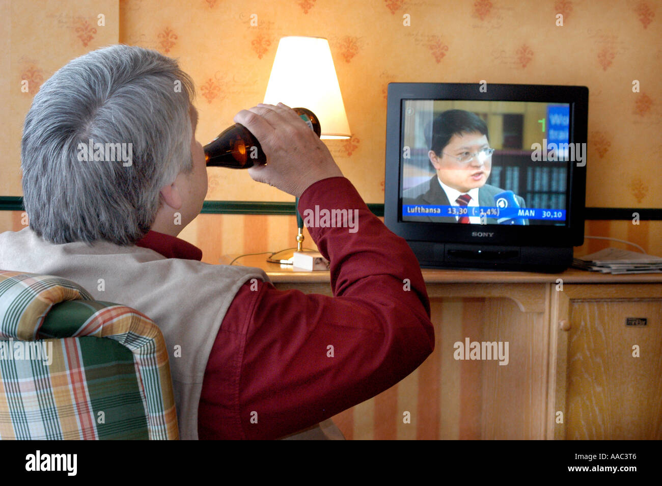 Man with beer before television set Stock Photo - Alamy