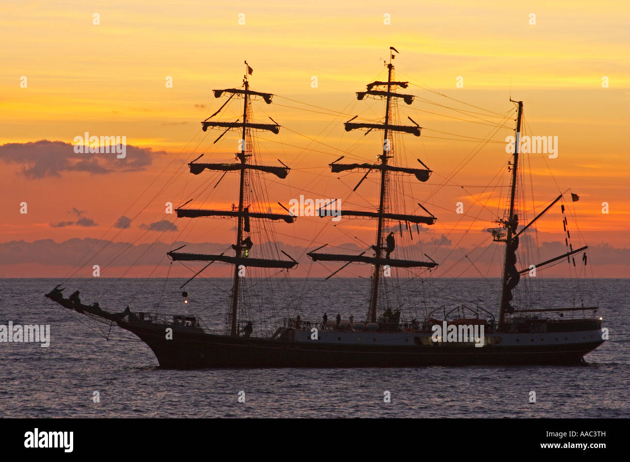 Tall ship at sunset Stock Photo - Alamy