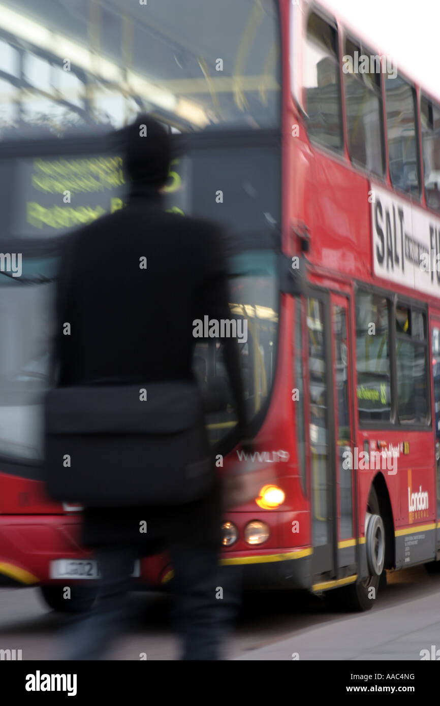 Commuter in front of bus Stock Photo - Alamy