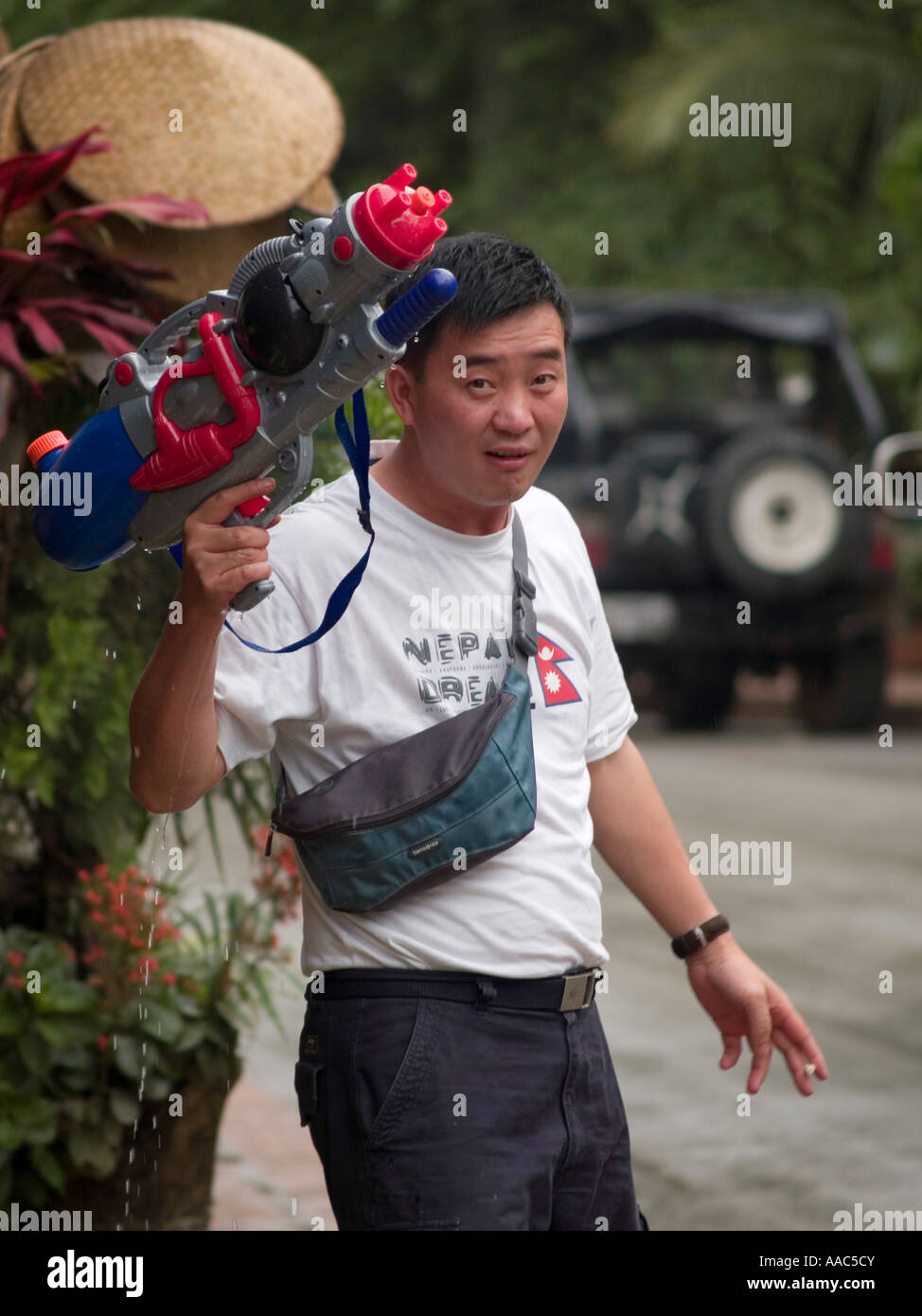 chinese guy with big water gun Lao Songkran New Year Luang Prabang ...