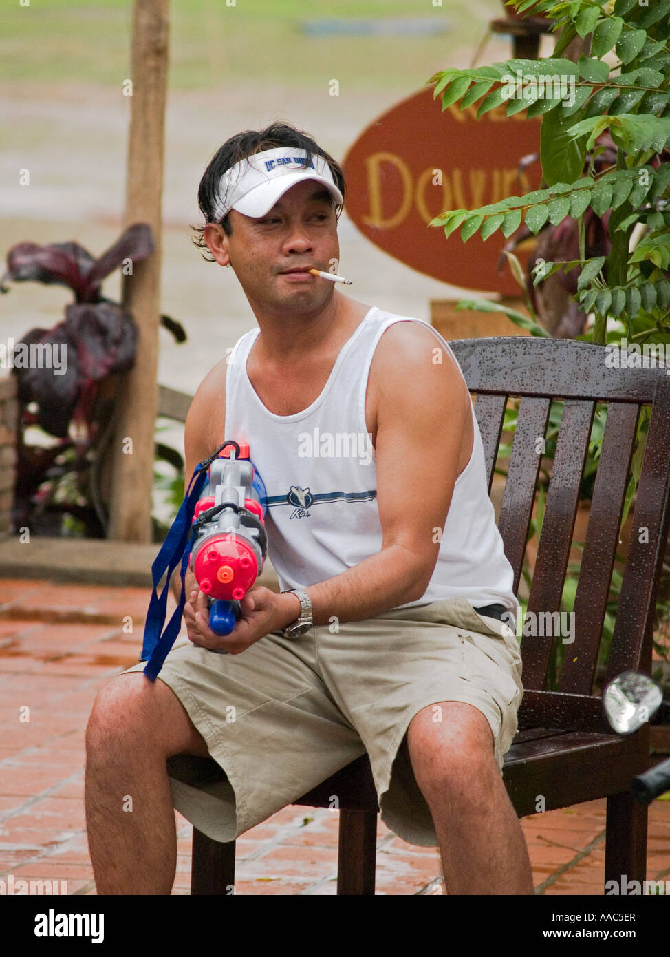 macho man with his smoke and gun at Songkran water festival Luang ...