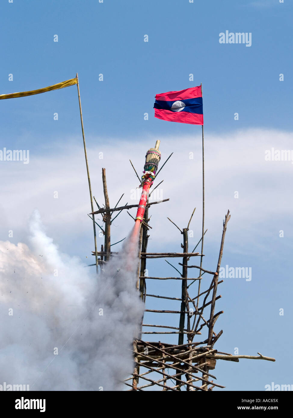 bamboo rocket blasts off under the Lao flag at the annual Bun Ban Fai ...