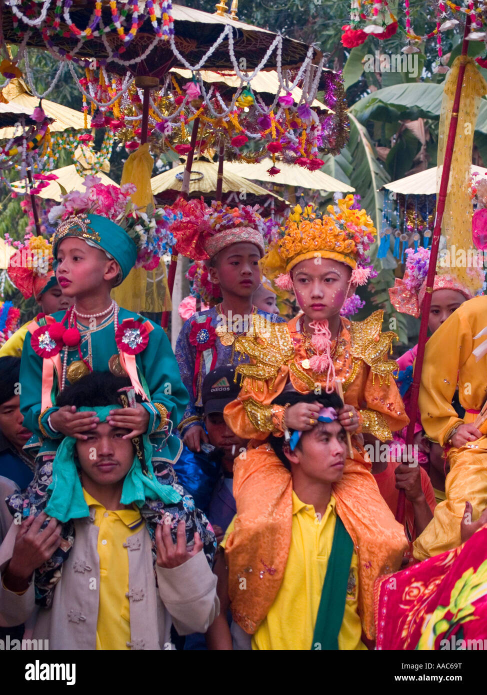 young monks not allowed to touch the ground are carried through the ...