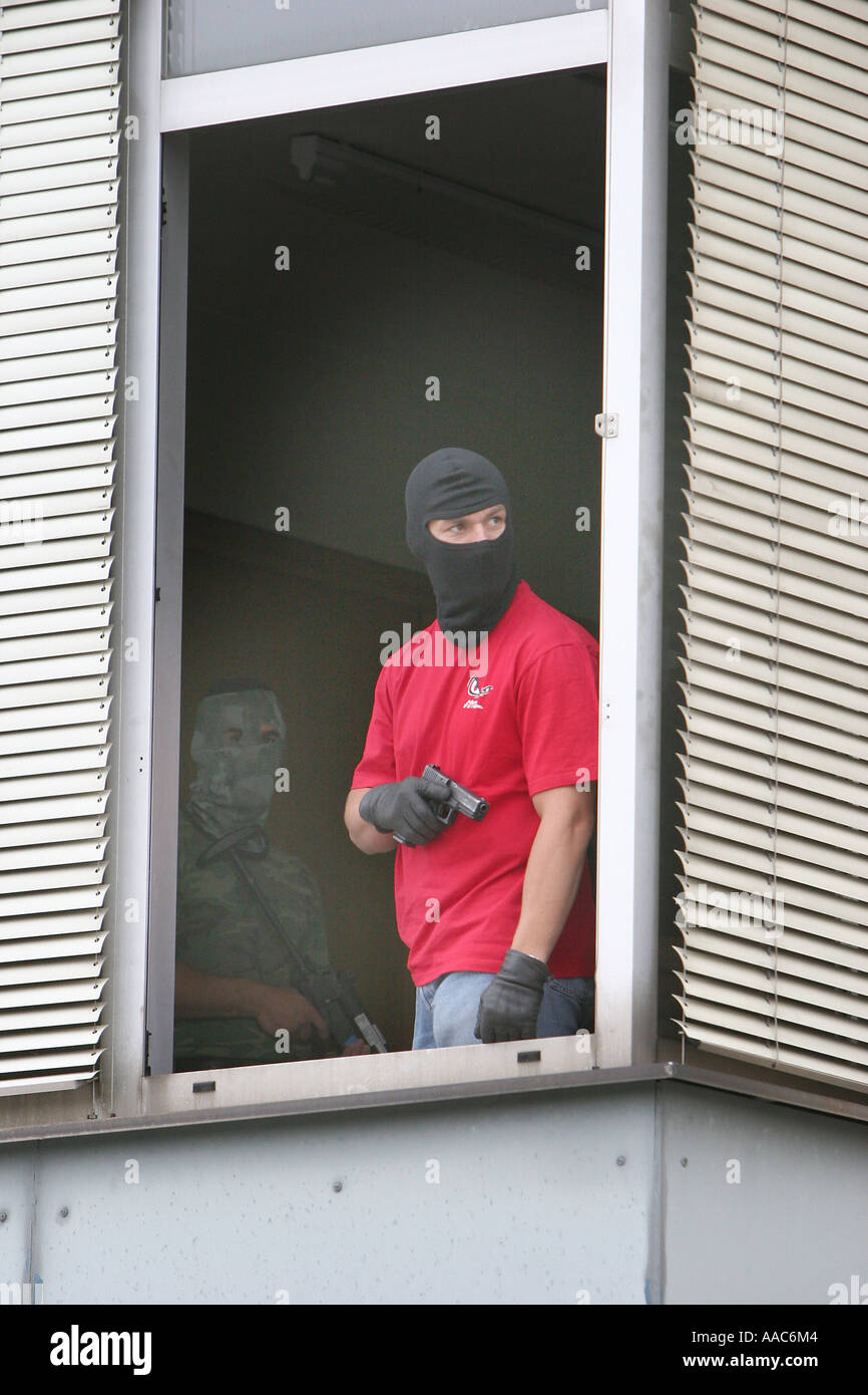Masked, armed criminals Stock Photo - Alamy