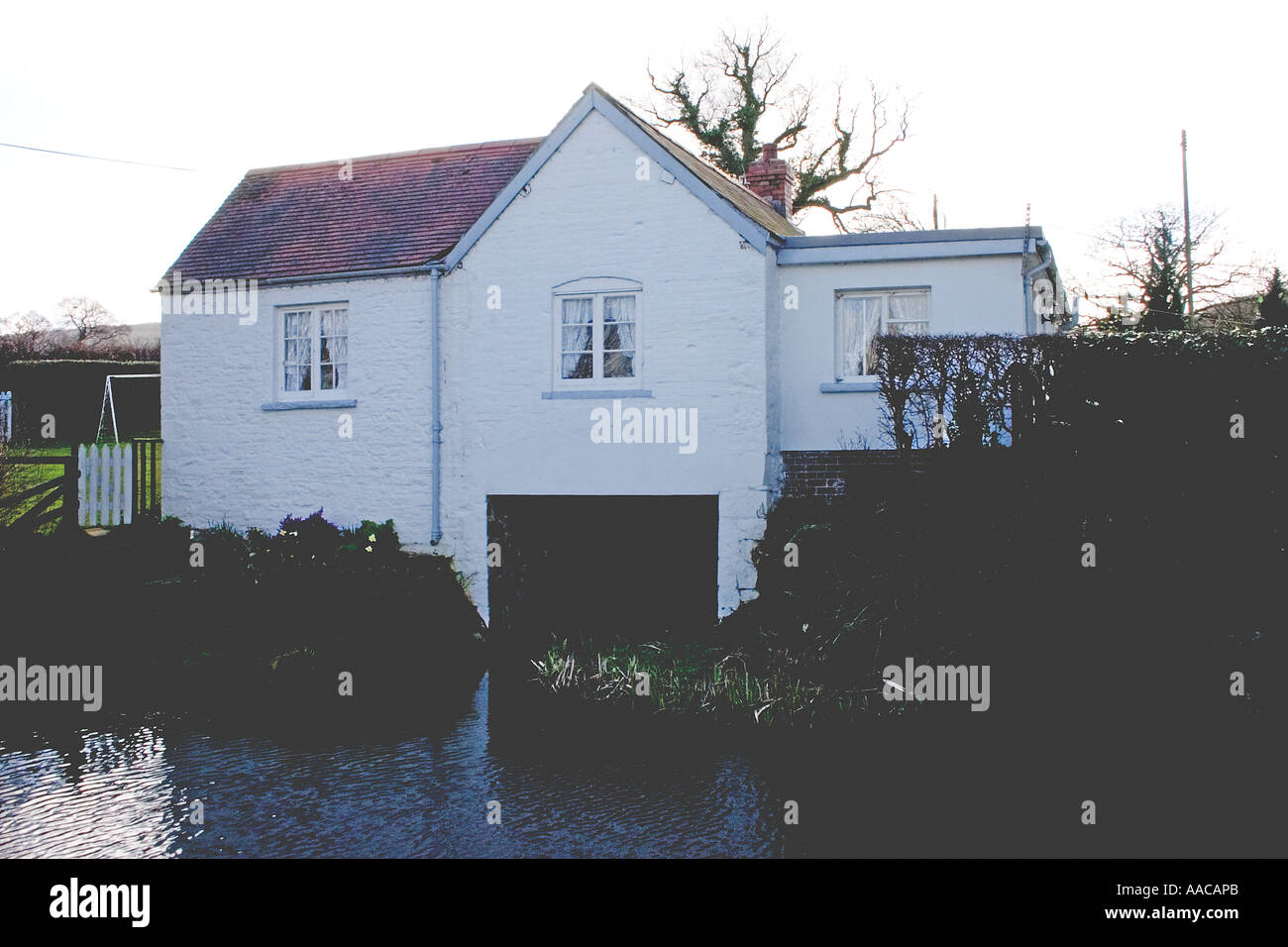 Canal side cottage with open boathouse beneath Brecon Monmouth canal ...