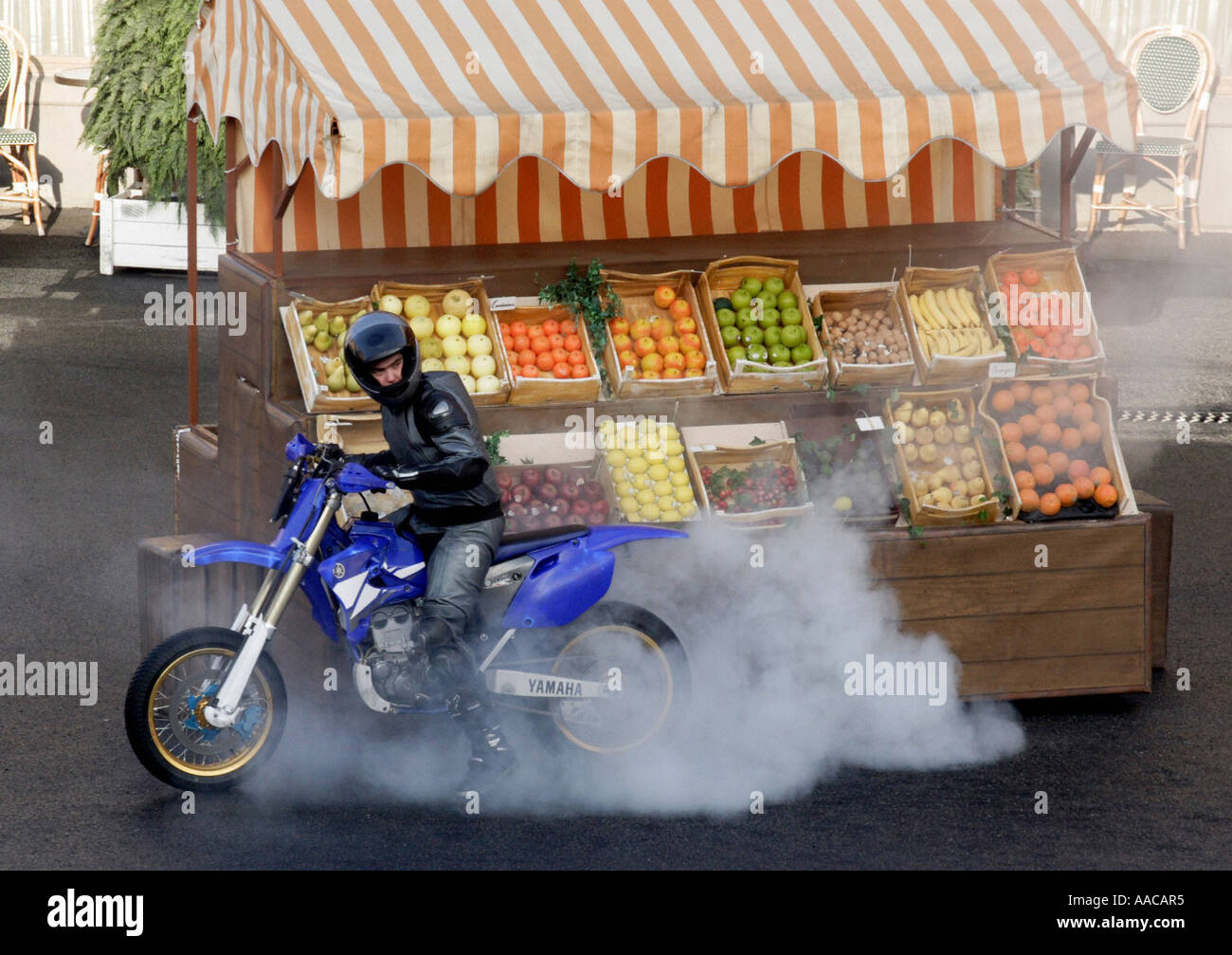 biker infront of a fruitstall Stock Photo - Alamy