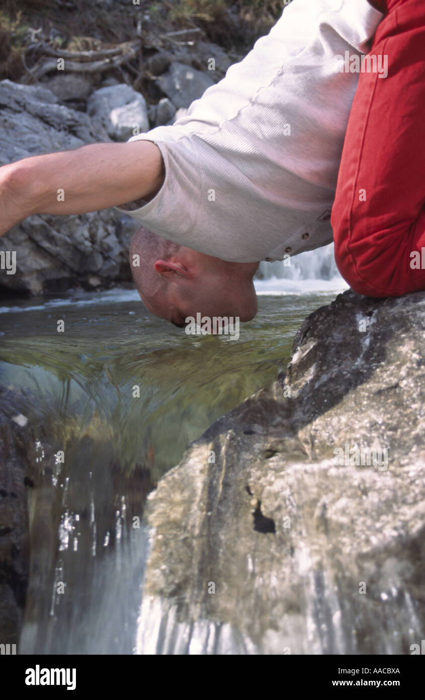man drinking from river Stock Photo - Alamy