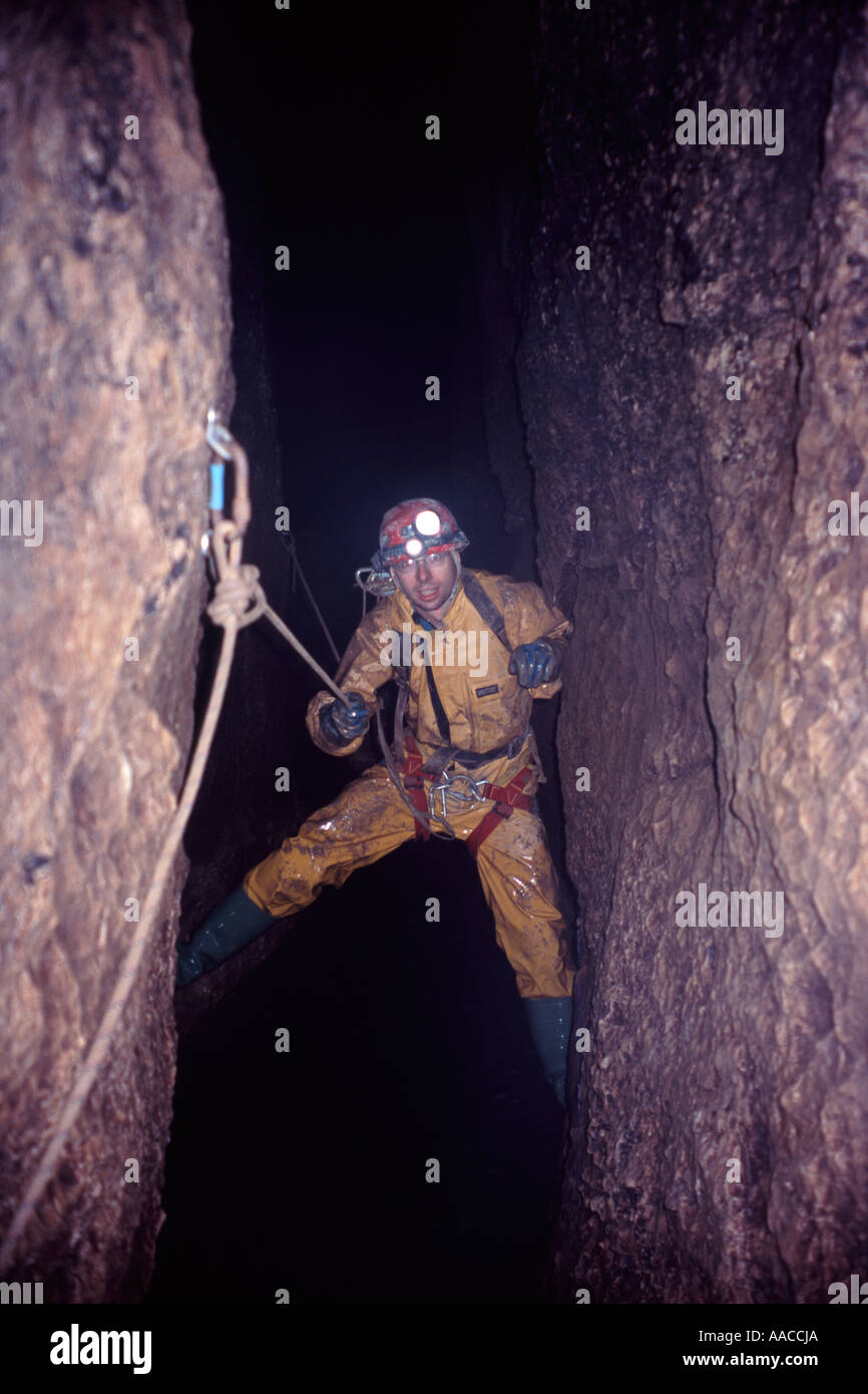 A caver uses SRT single rope techniques to rig a traverse in the ...