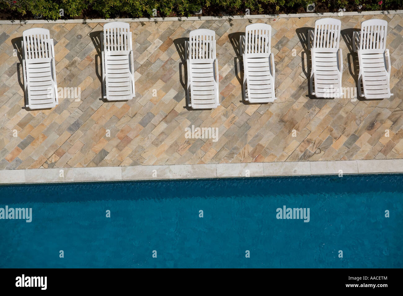 Chairs for relaxing near swimming pool Stock Photo - Alamy