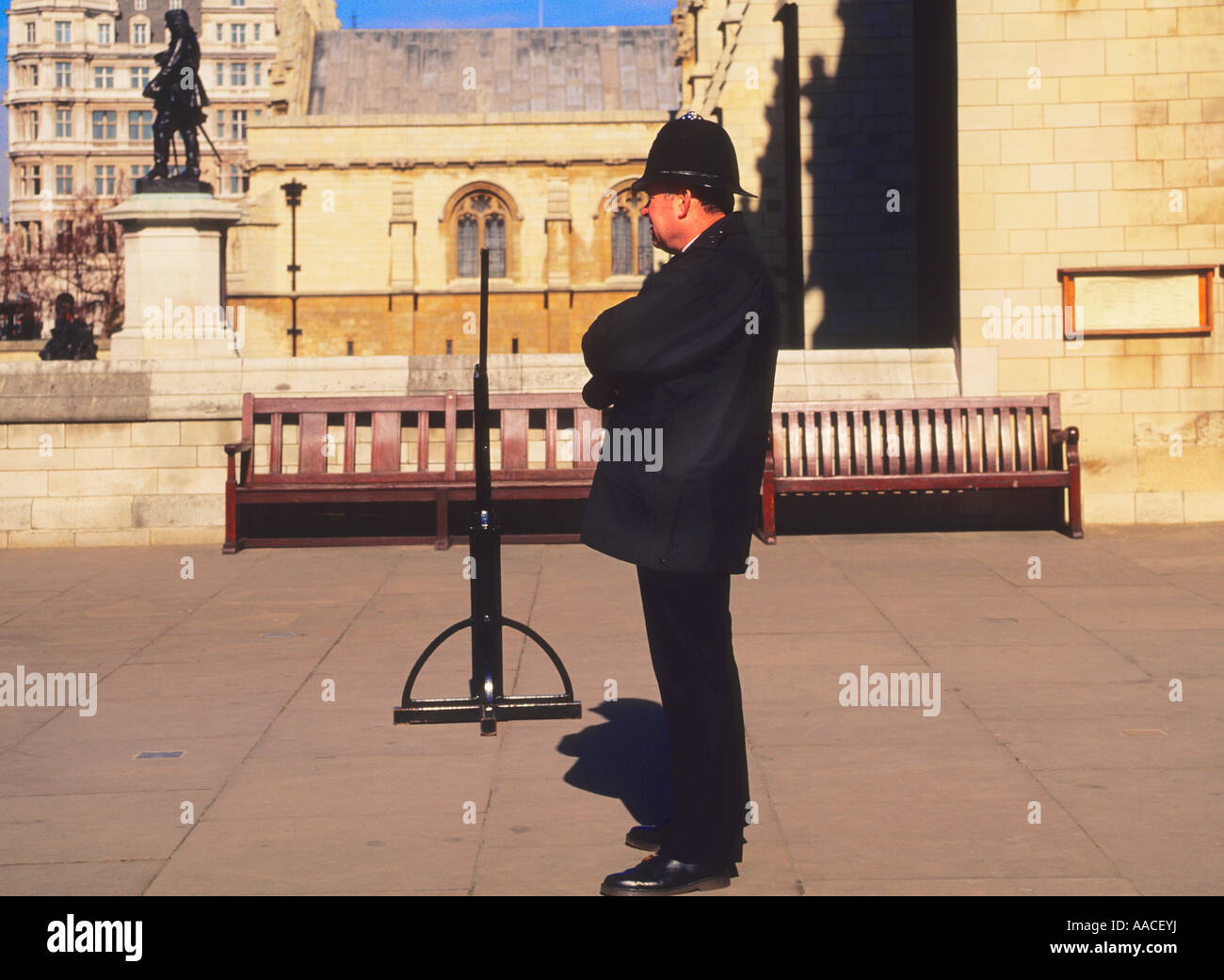 Bobby, police officer, standing alone on a London street. English ...