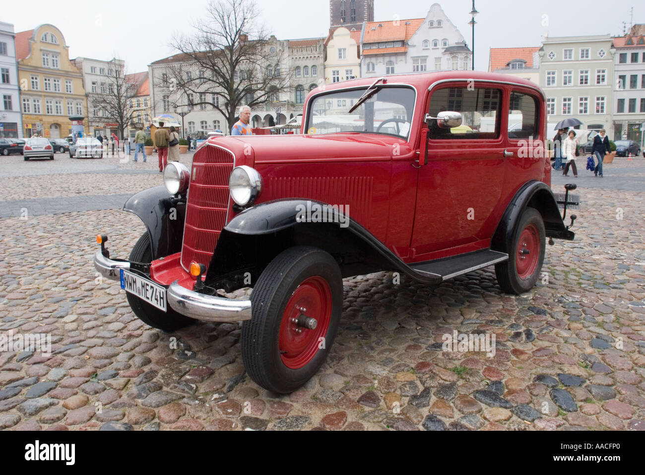 Old red Opel P4 car in the market place in Hanseatic Wismar, North ...