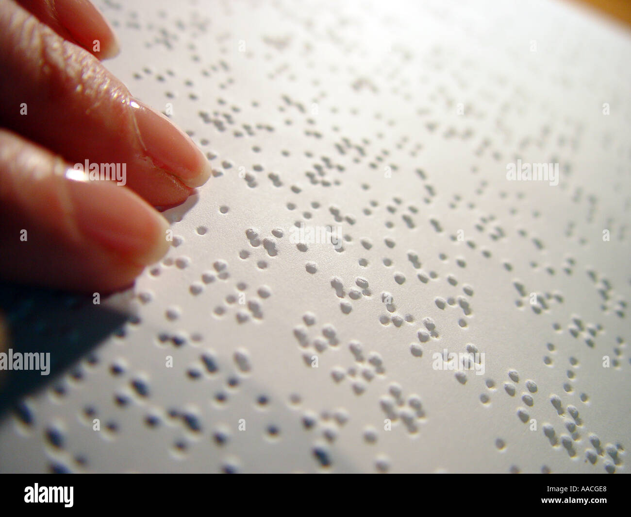 Braille reader with female hand Stock Photo - Alamy