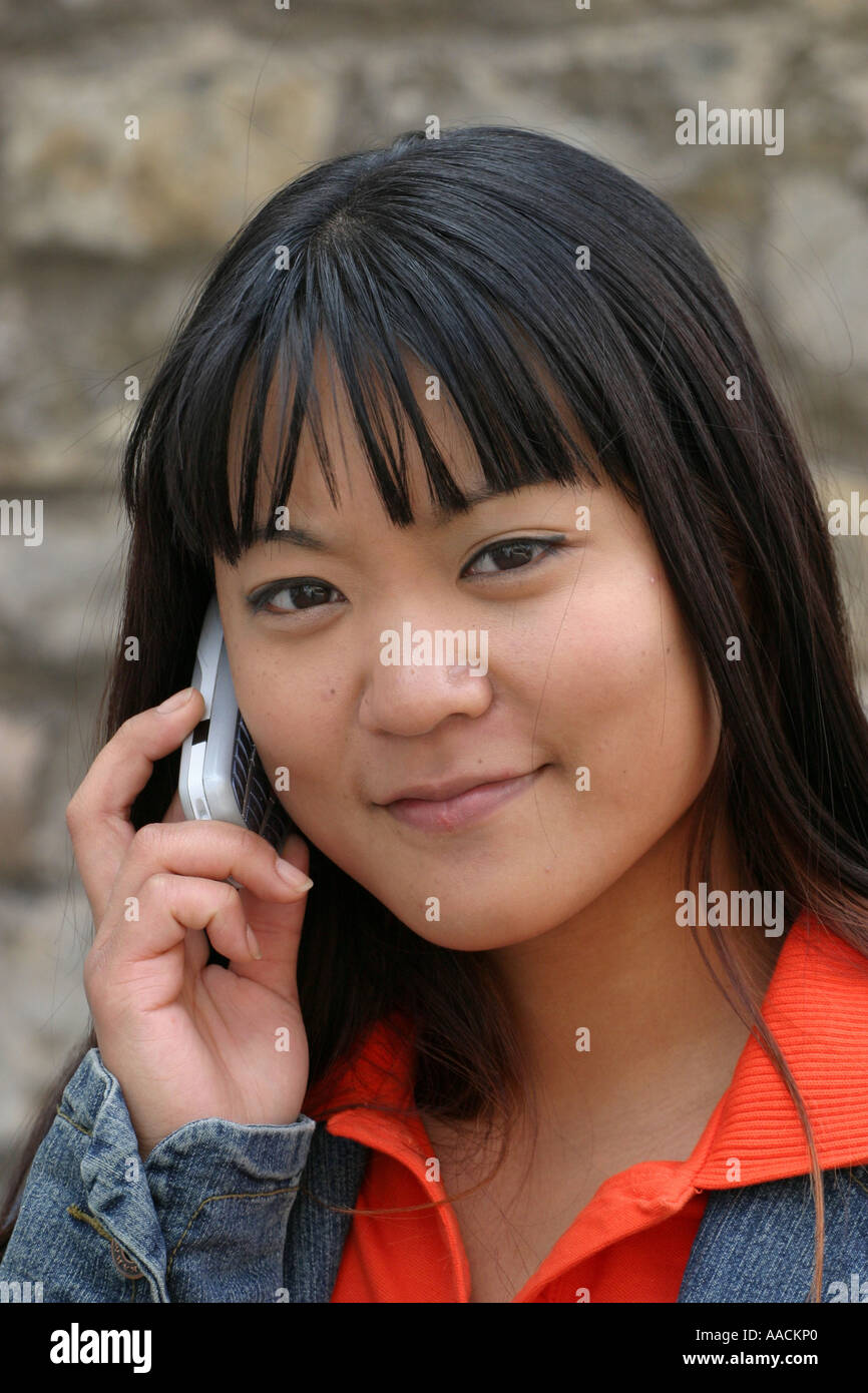 Asian with mobile phone Stock Photo - Alamy
