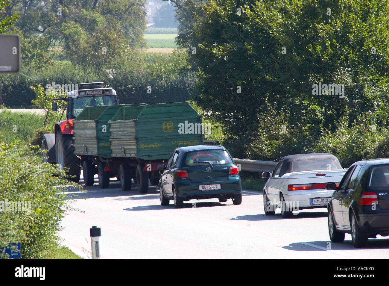 vehicle convoy behind a tractor Stock Photo - Alamy