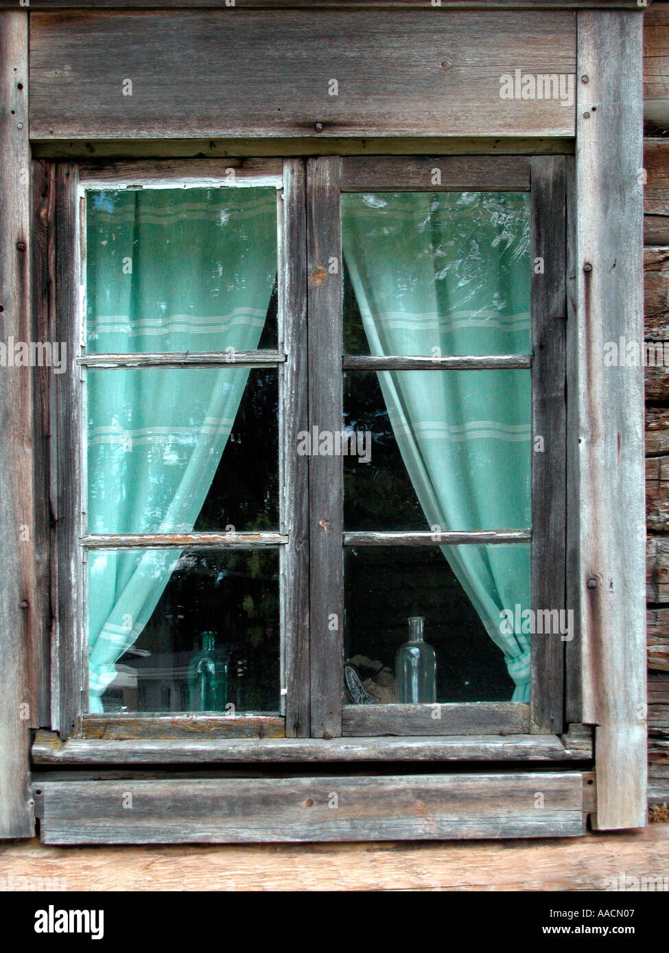 window of an old blockhouse with green curtains Stock Photo - Alamy