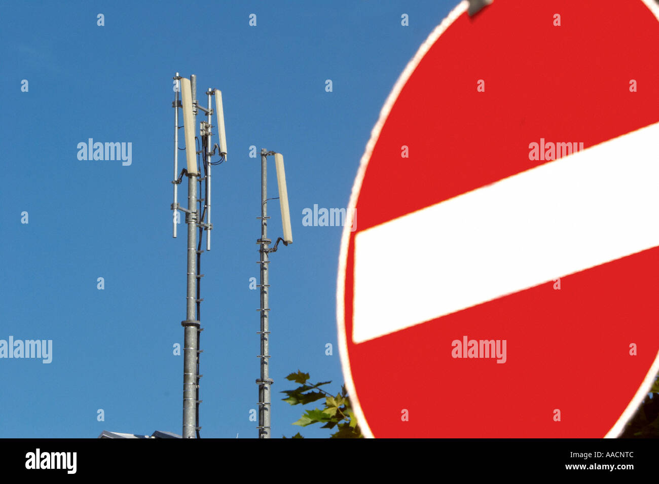 Mobile phone pole with one-way board Stock Photo - Alamy