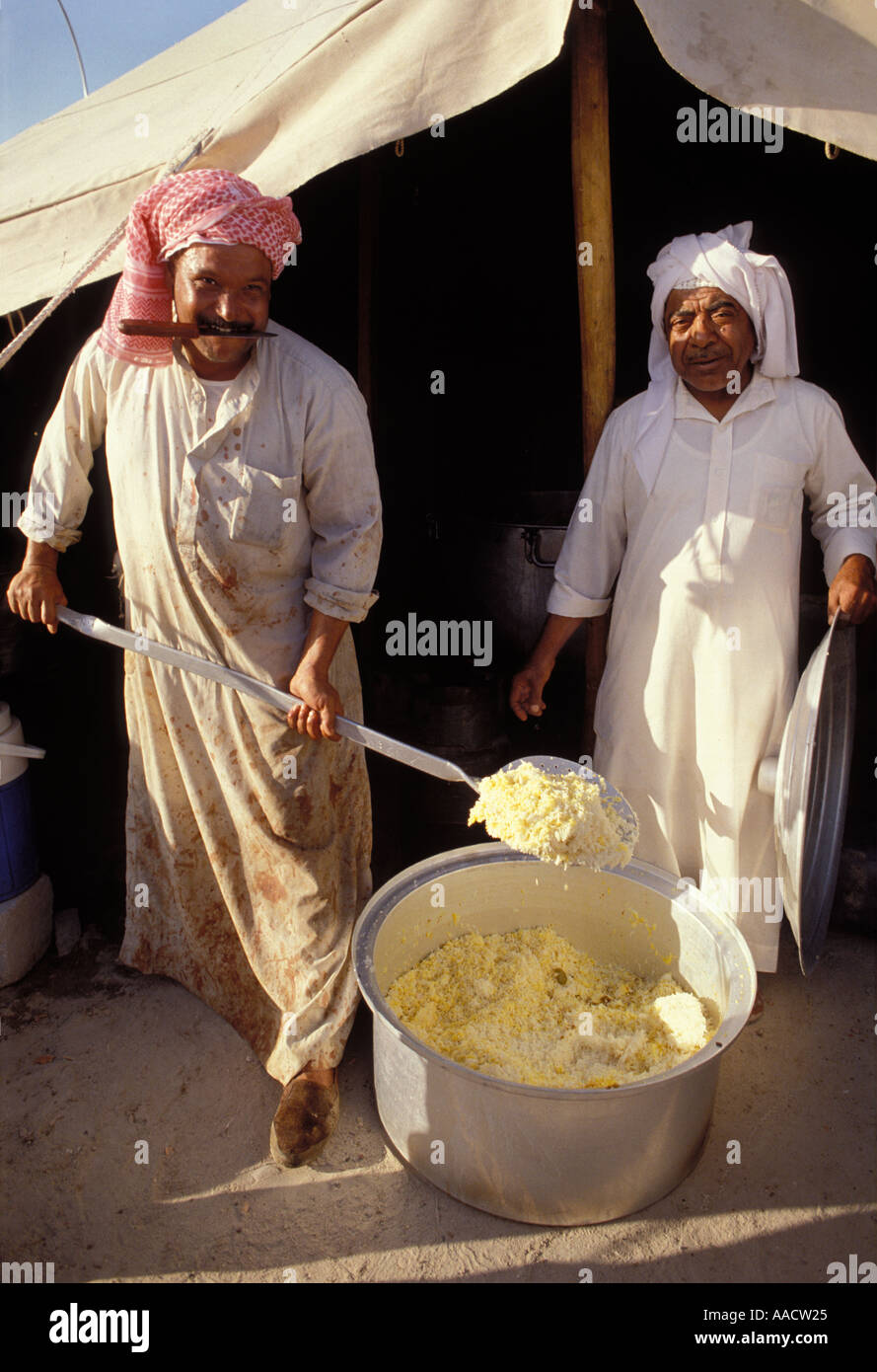 Nomads prepare feast in huge pot in desert Kuwait Stock Photo - Alamy