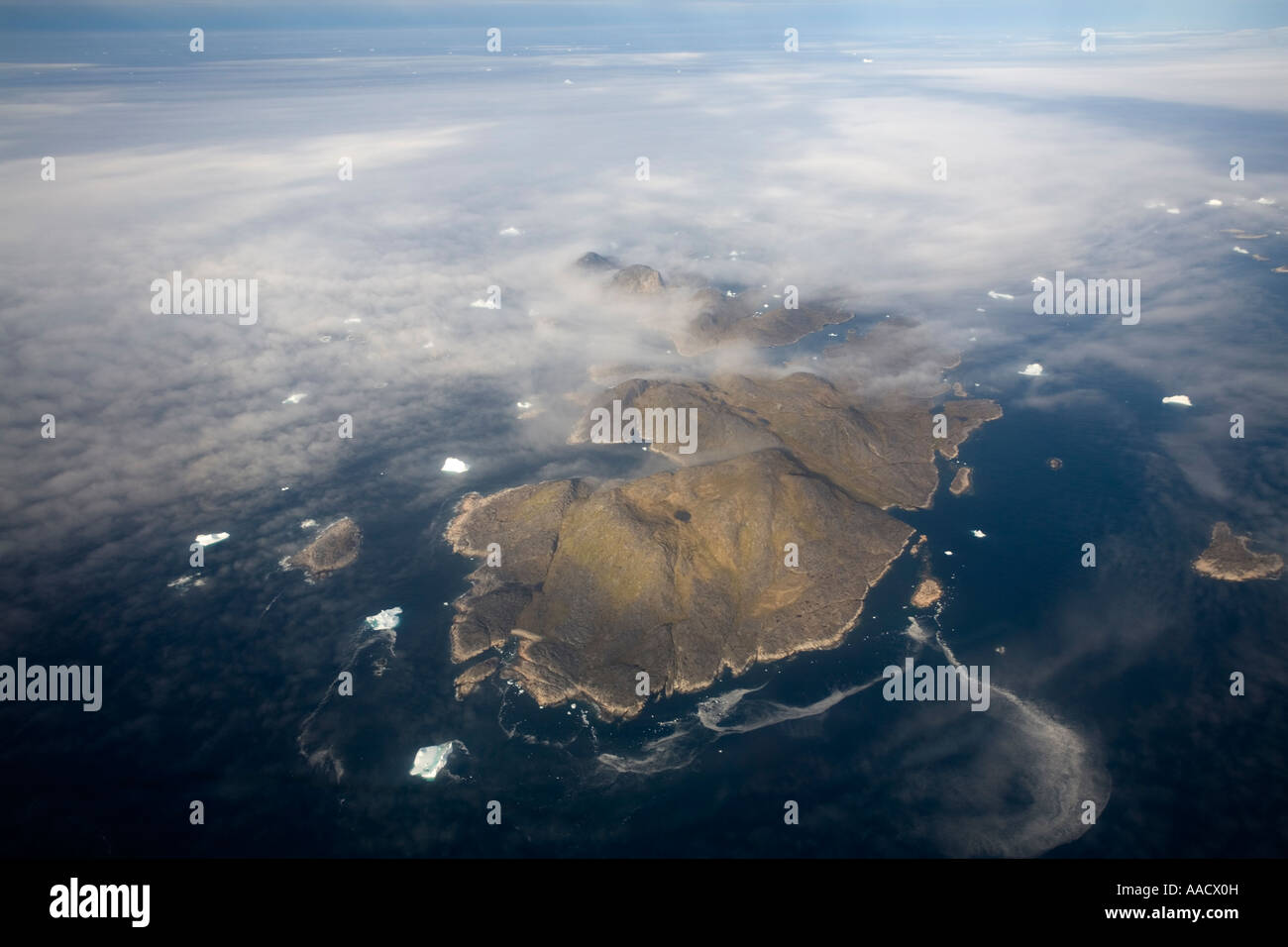 Greenland Narsarsuaq Aerial view of icebergs filling mountain lined ...