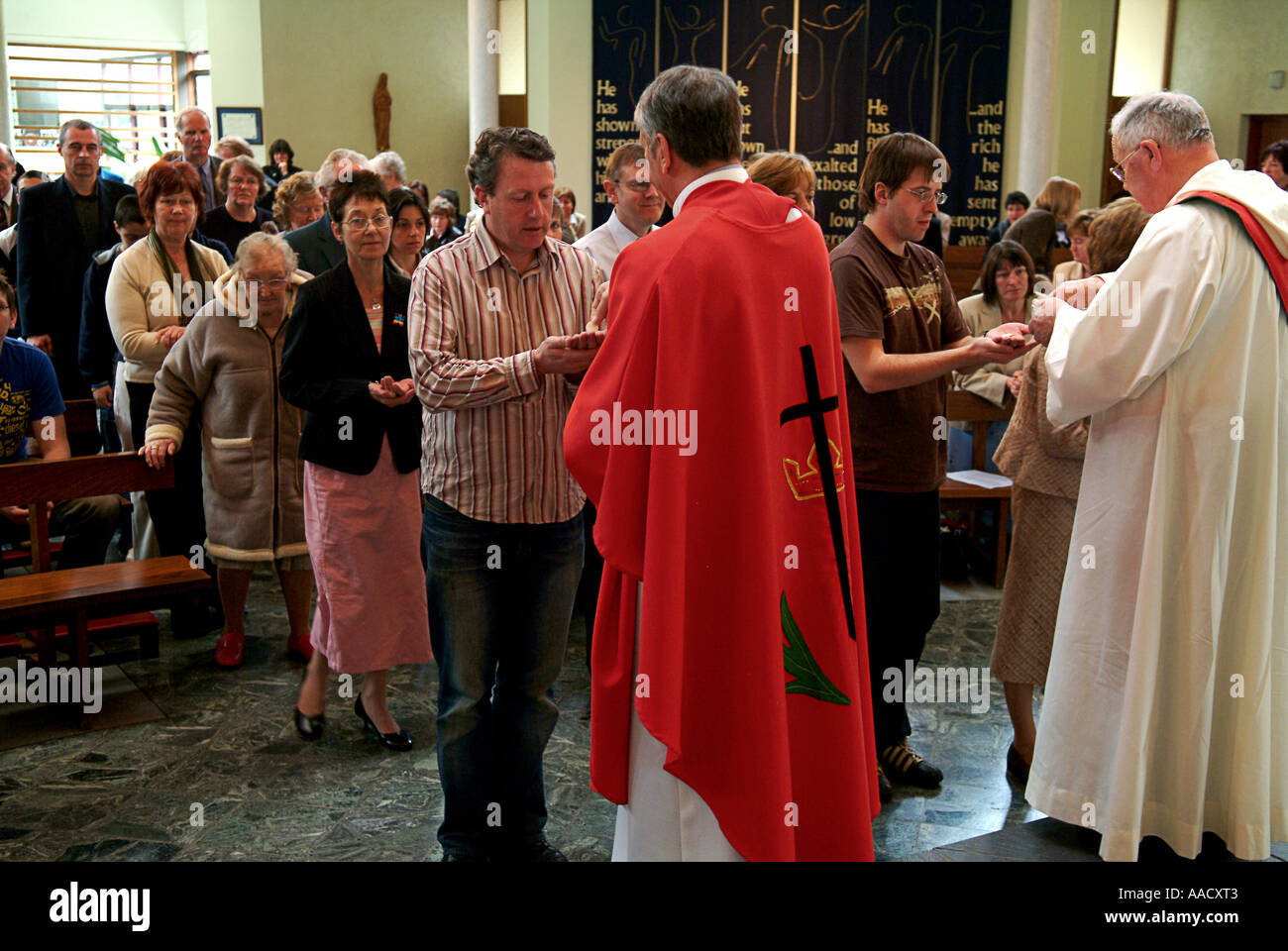 Distribution of the Eucharist during the first mass of a newly ordained ...