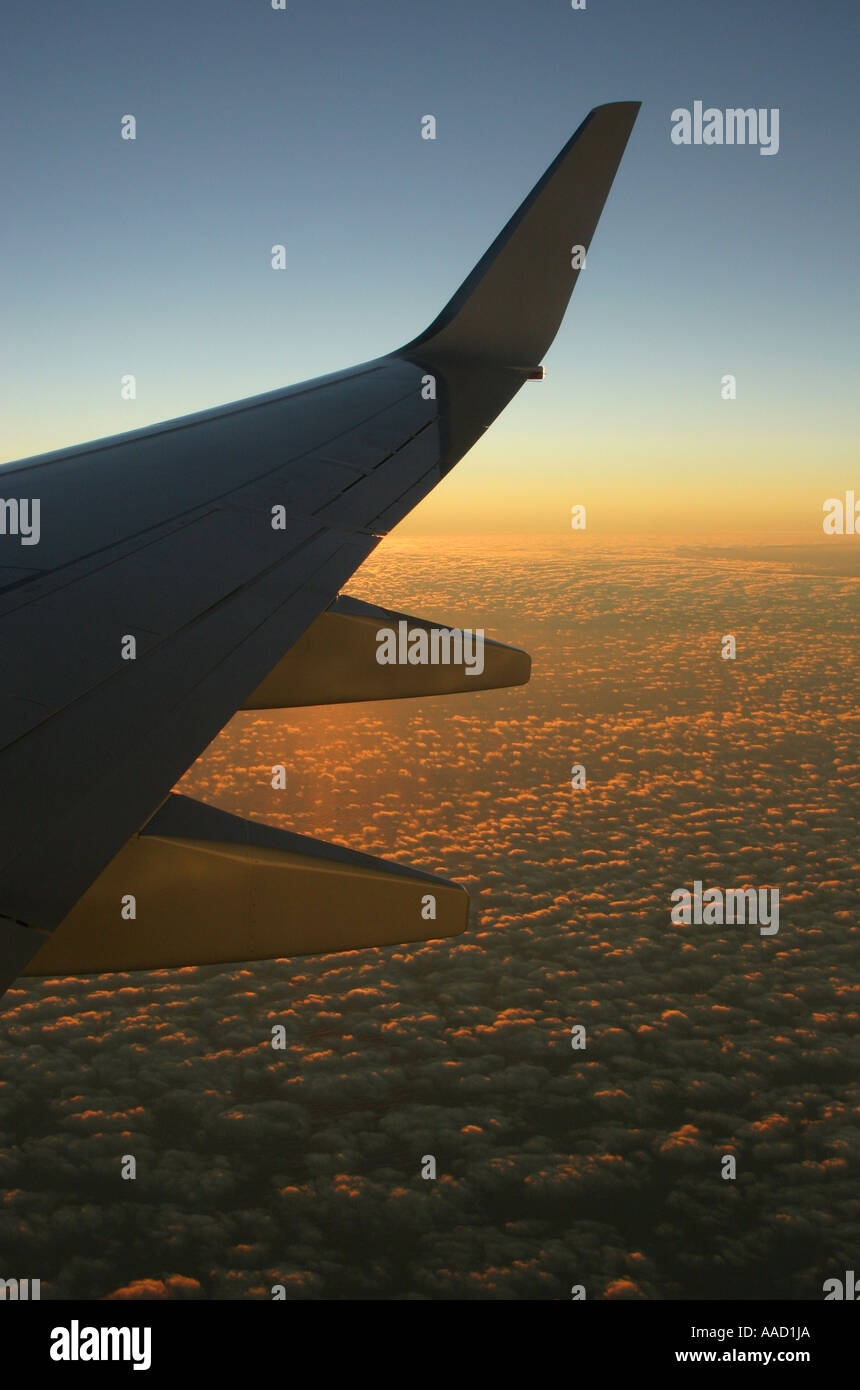 Sunset behind the wing of an A320 aircraft over the Bass Strait between ...