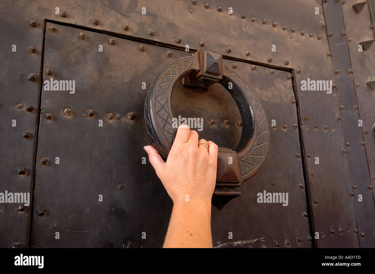 massive knocker with female hand Stock Photo - Alamy