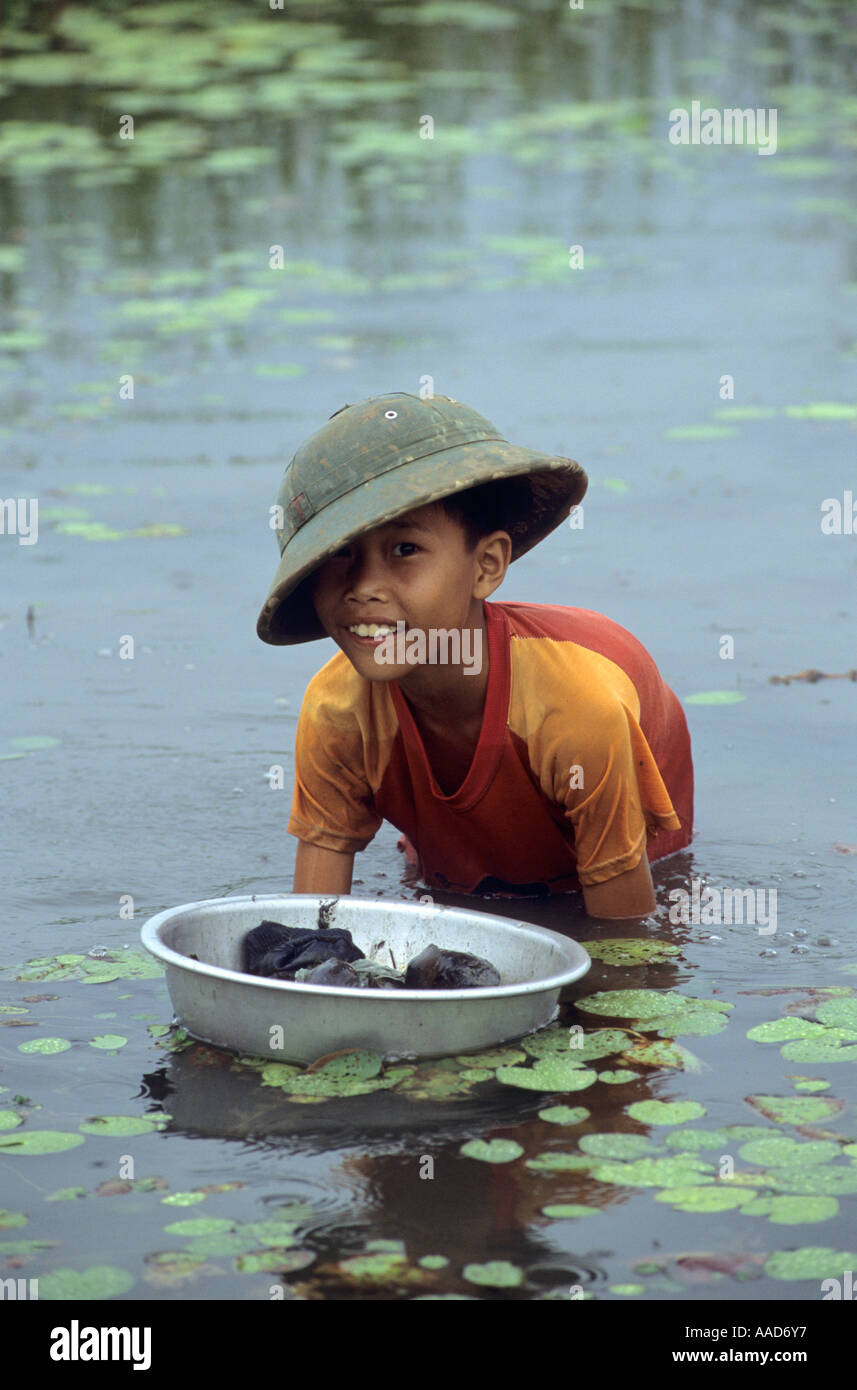 Van Long Nature Reserve Vietnam. Young boy collecting freshwater ...