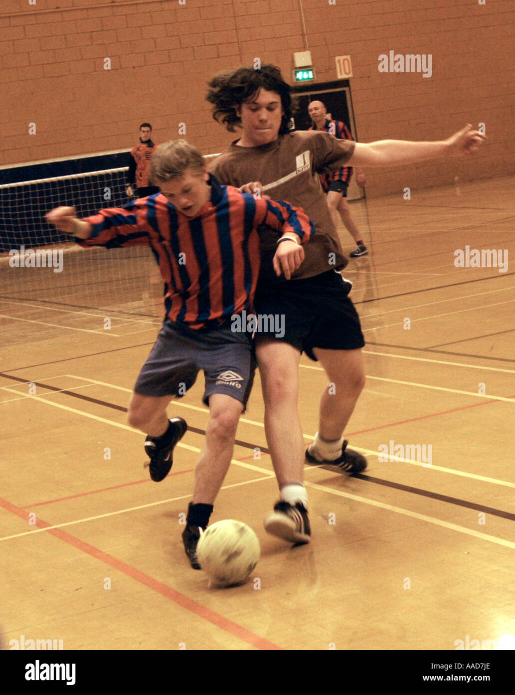 Sixth form college students play football in gym Stock Photo - Alamy