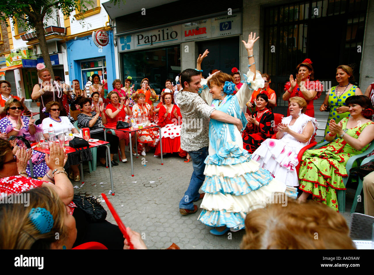 Women Wearing Traditional Flamenco Dresses Dancing In The Street During