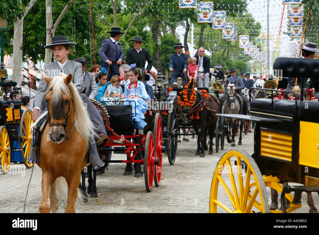 People sitting on a horse drawn carriages at the April Fair Seville ...