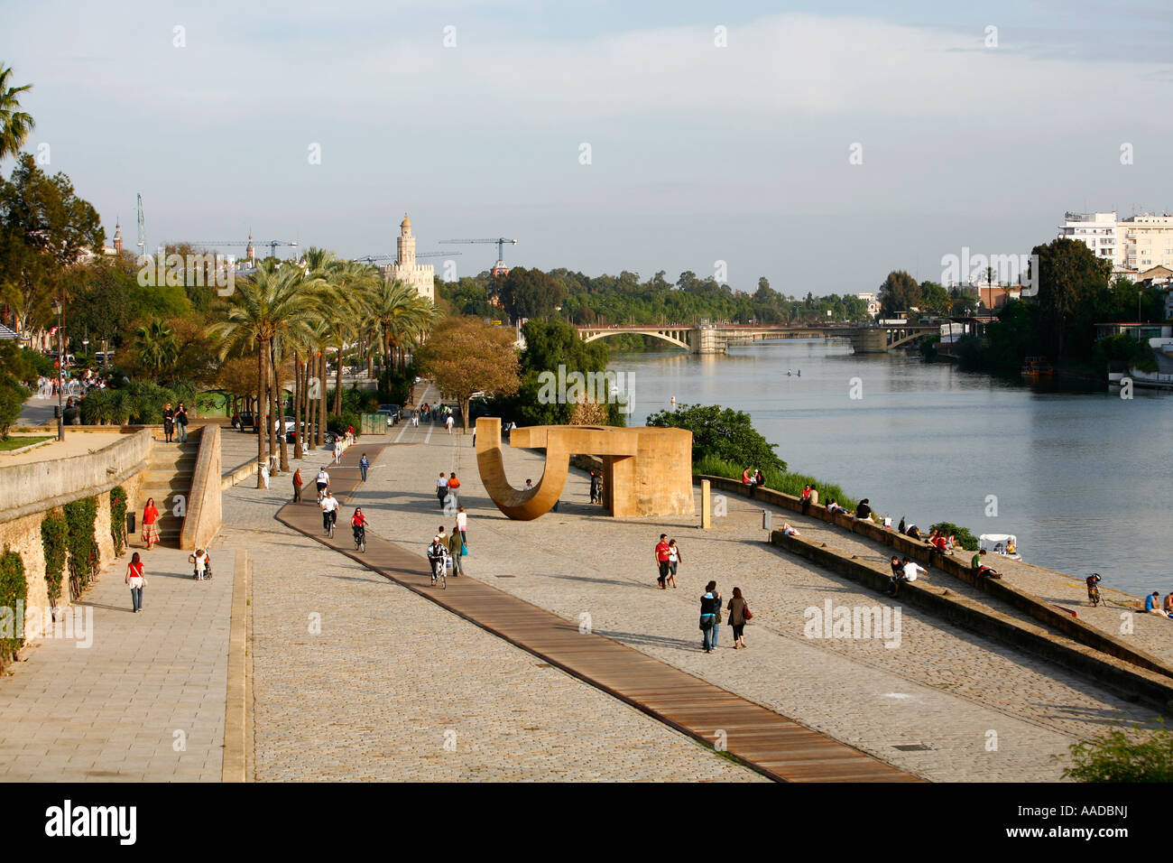 People walking by the Guadalquivir River Seville Spain Stock Photo - Alamy