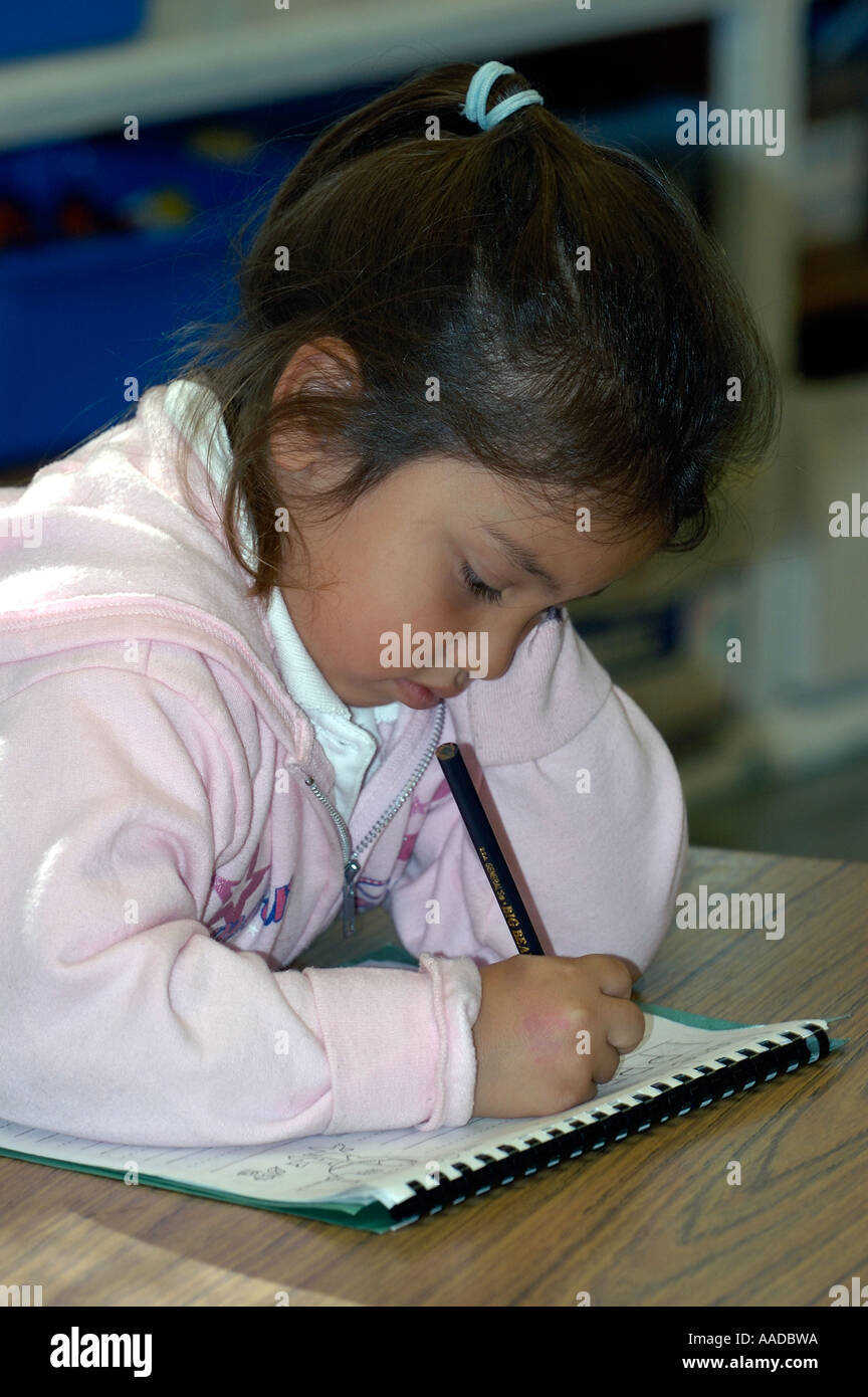 Hispanic student writing Stock Photo - Alamy