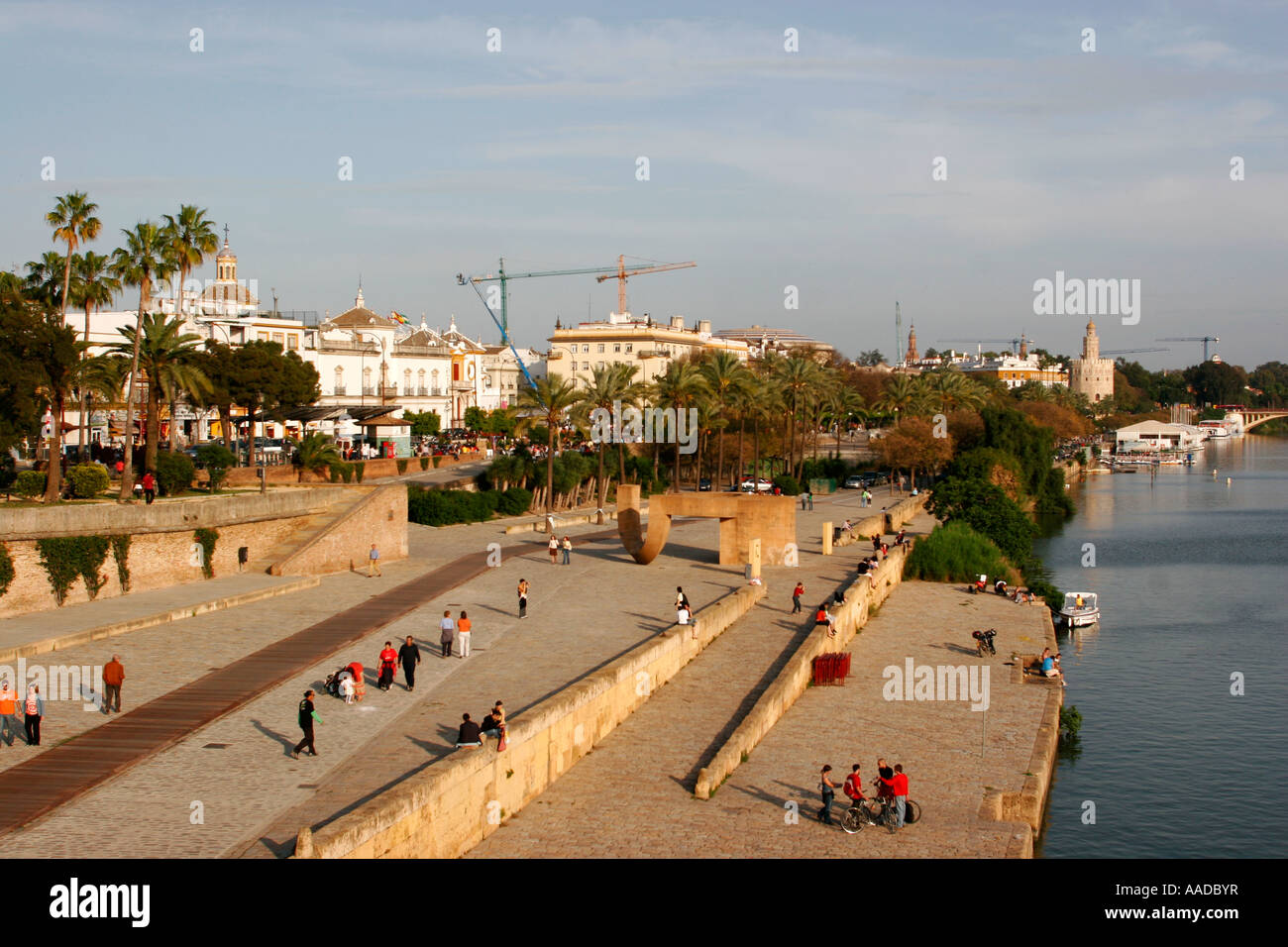 People walking by the Guadalquivir River Seville Spain Stock Photo - Alamy