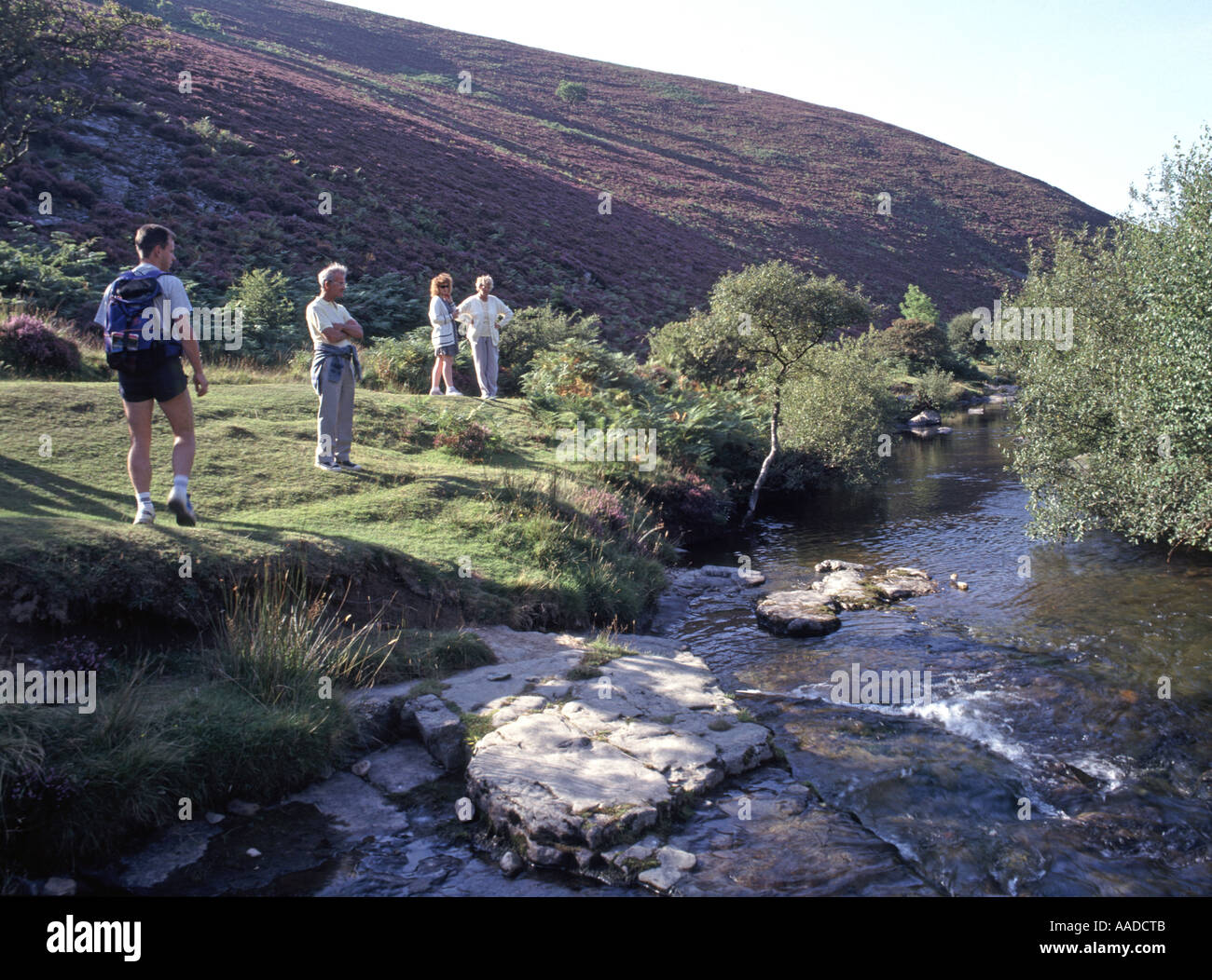 Walker on footpath in tranquil scenery of Doone Valley landscape beside ...
