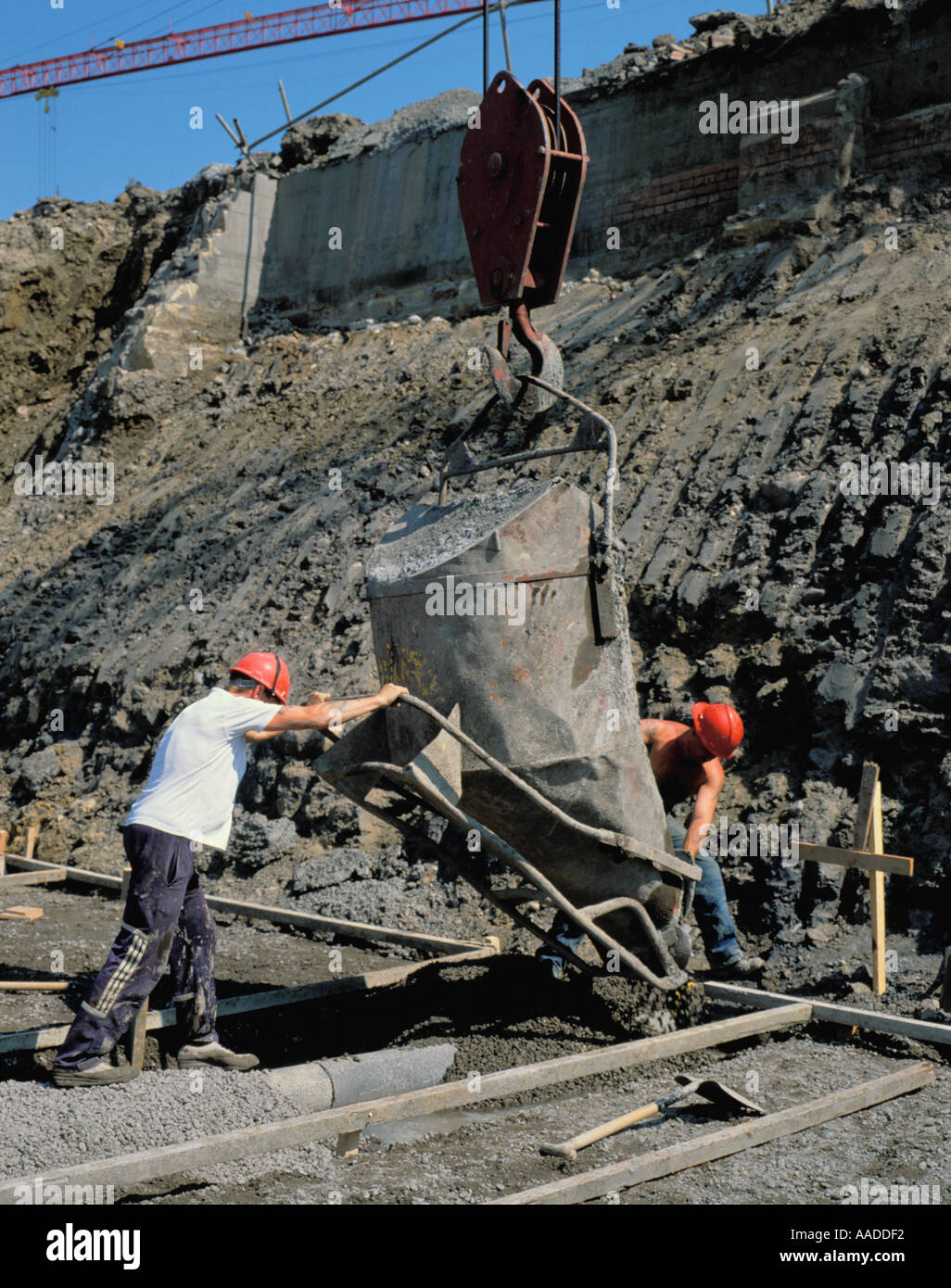 Workmen pouring concrete from a skip on a construction site, UK Stock ...