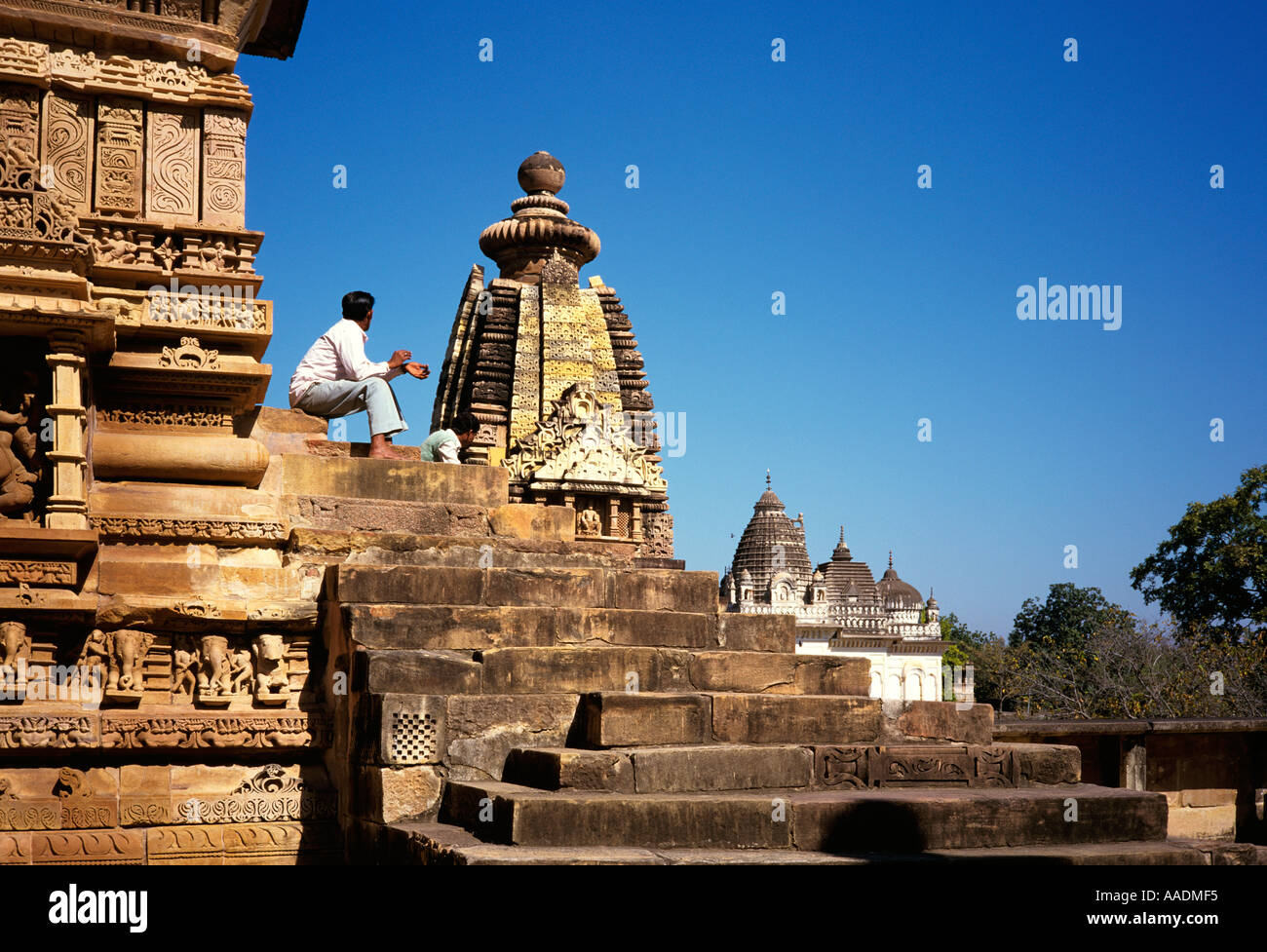 India Madhya Pradesh Khajuraho man sat on steps of the Vishvanatha ...