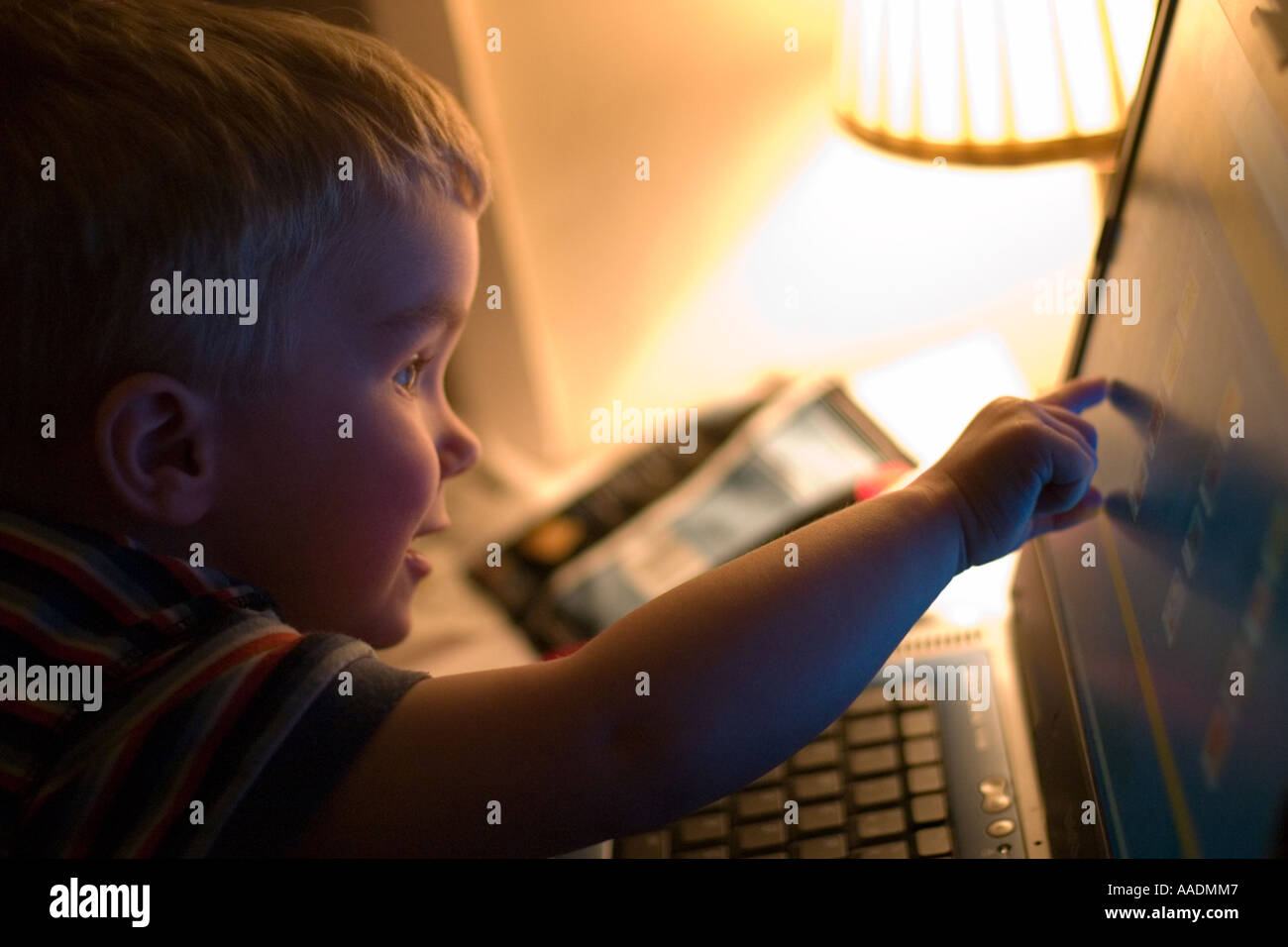 Child touching laptop computer screen Stock Photo - Alamy