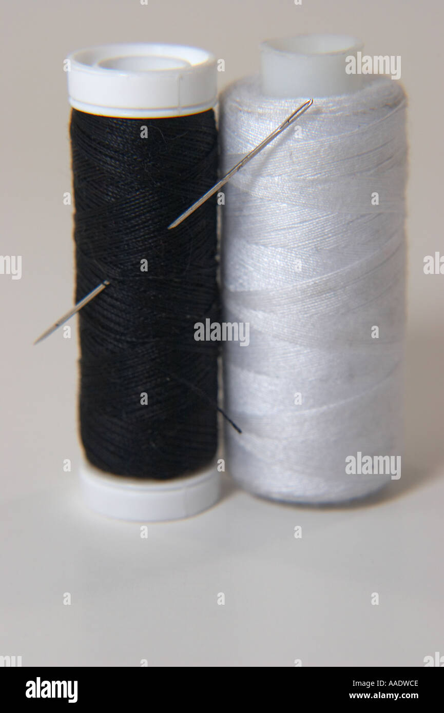 Black and white sewing threads with needle Stock Photo - Alamy