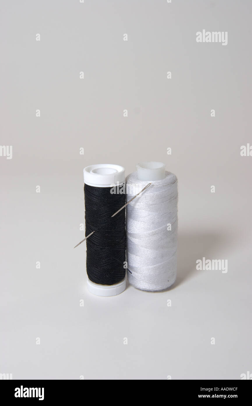 Black and white sewing threads with needle Stock Photo - Alamy