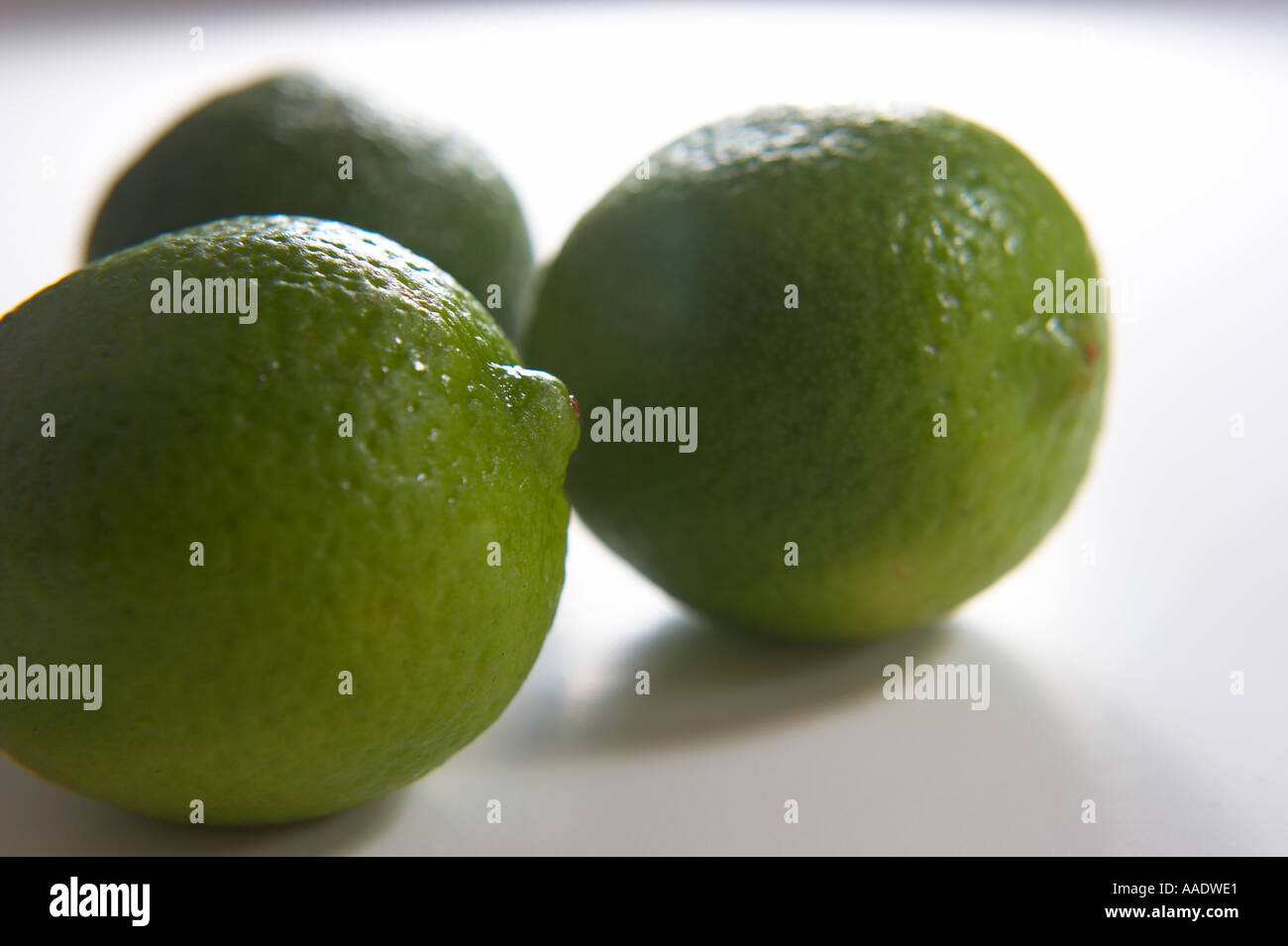 Three limes on white background Stock Photo - Alamy