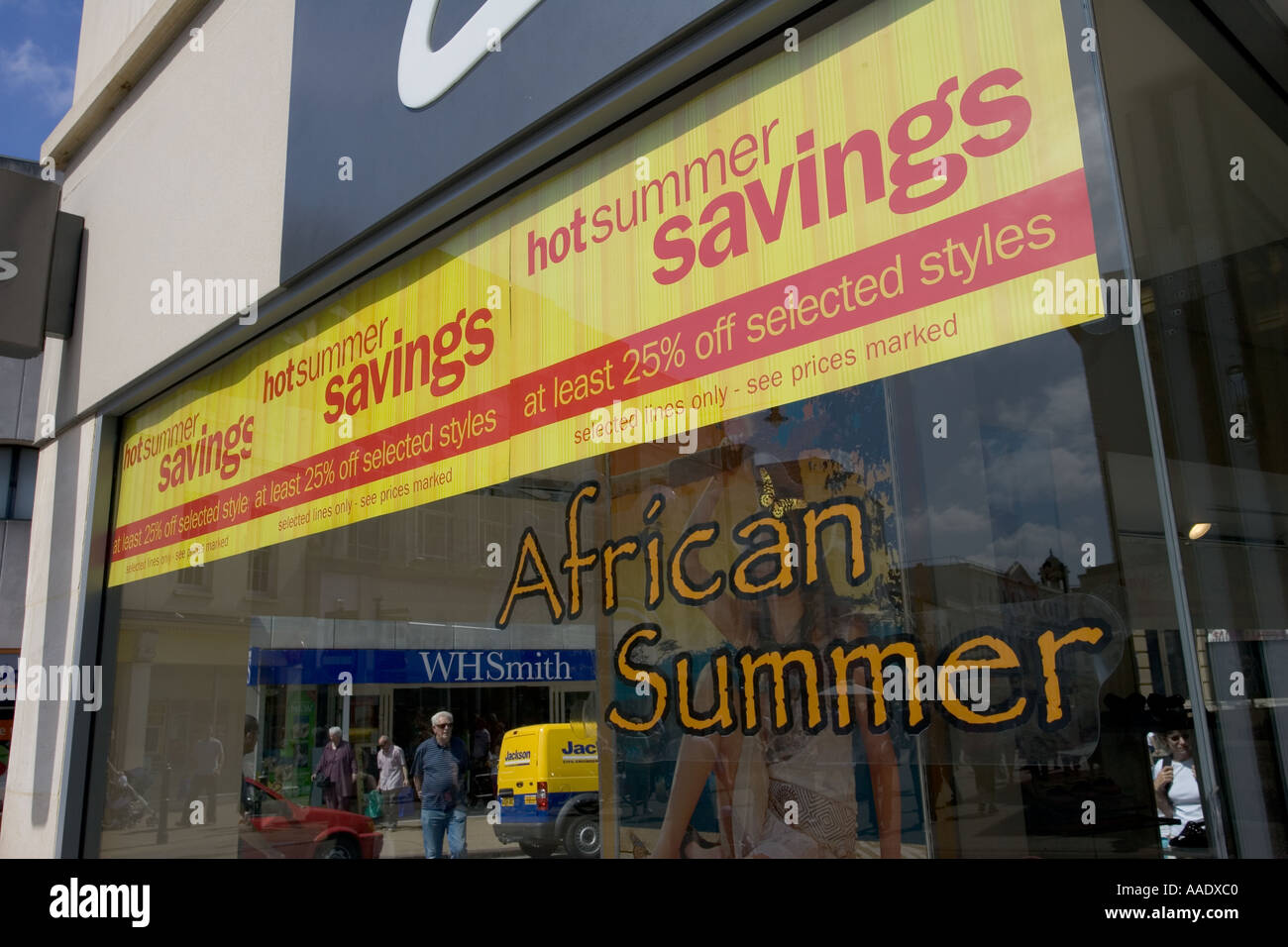 Hot summer savings and African Summer banners in shop window Cheltenham ...