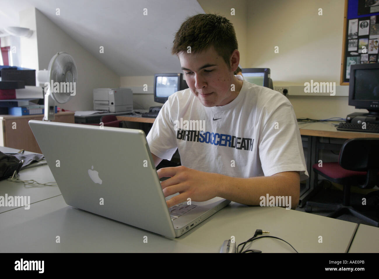 Student using Apple Macintosh laptop computer in sixth form college ...