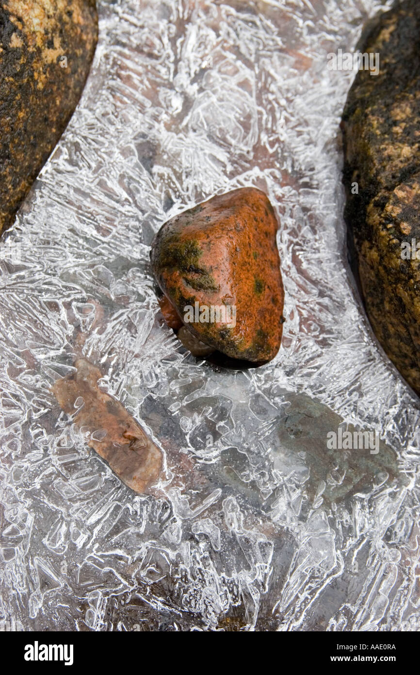 Rocks embedded in ice in a river Stock Photo - Alamy