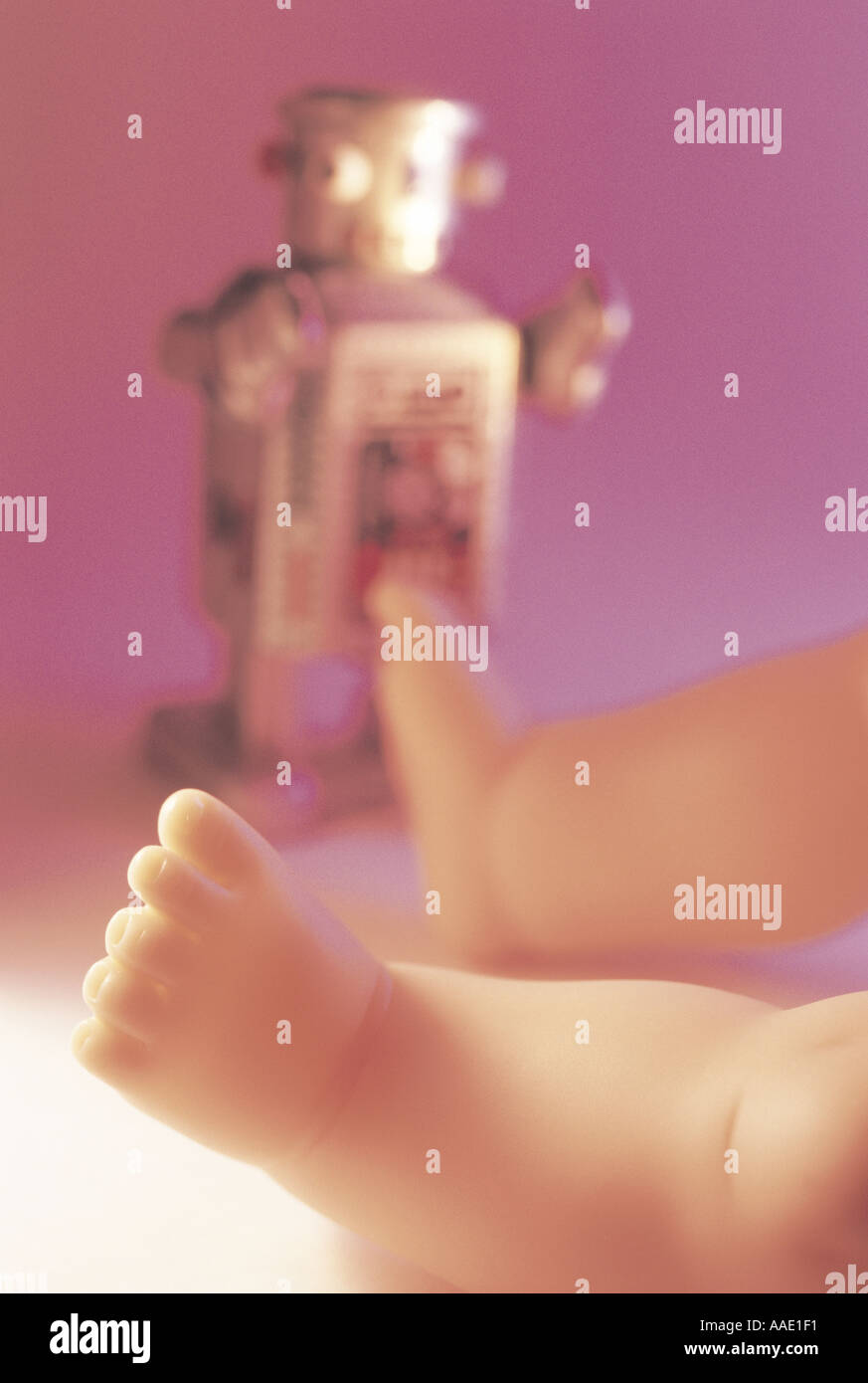 Toy Robot at Doll's Feet Stock Photo - Alamy