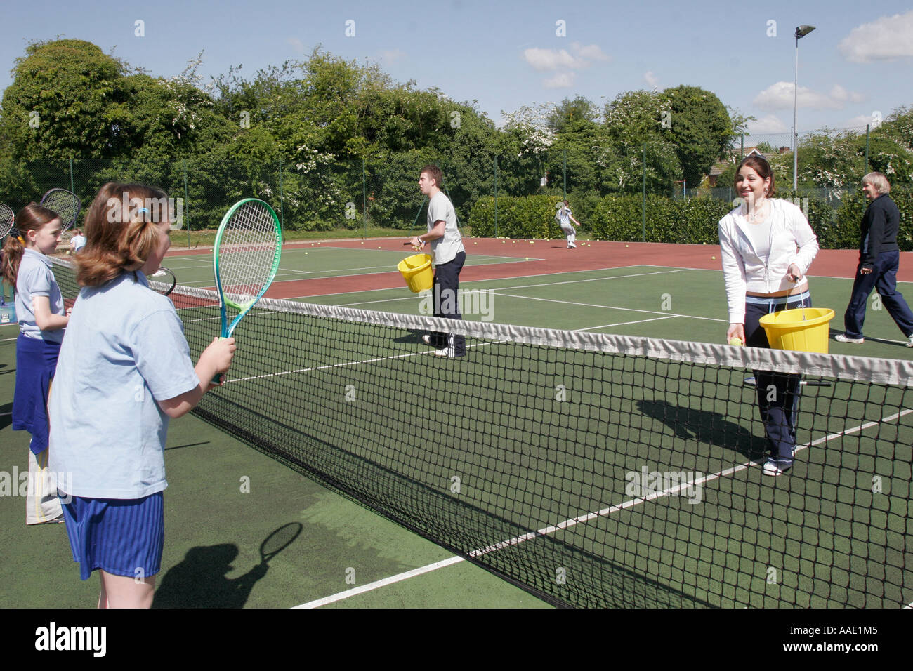 Sixth form students teaching tennis to primary school pupils Stock ...