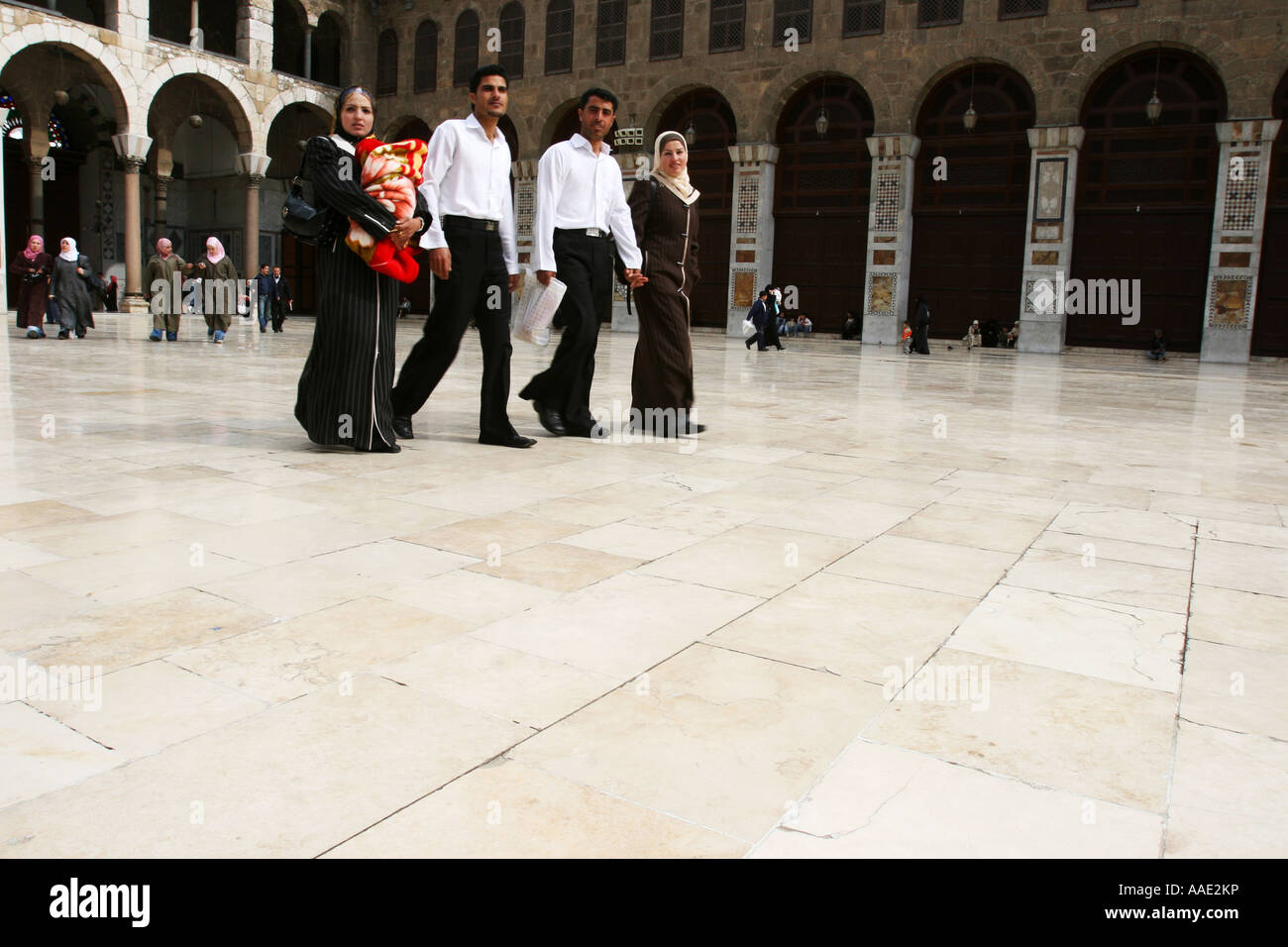 A family walk in the courtyard of The Umayyad Great Mosque, Old Town ...