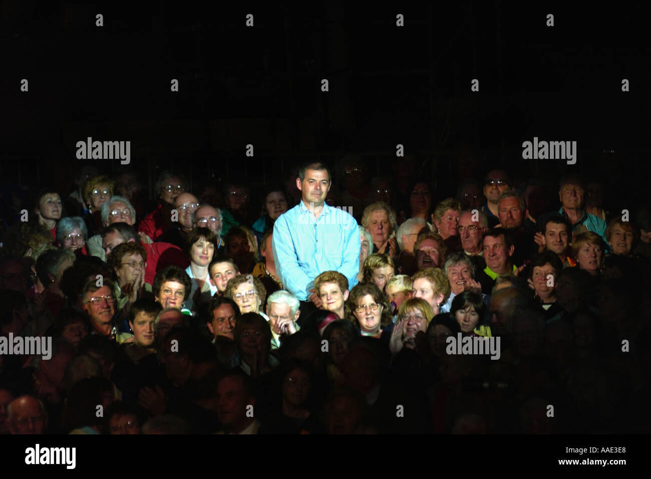 Spotlight On Person In Crowd