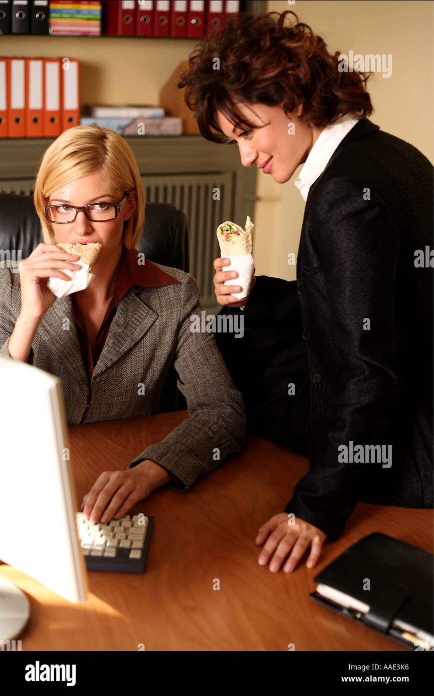 Two women working at the computer Stock Photo - Alamy