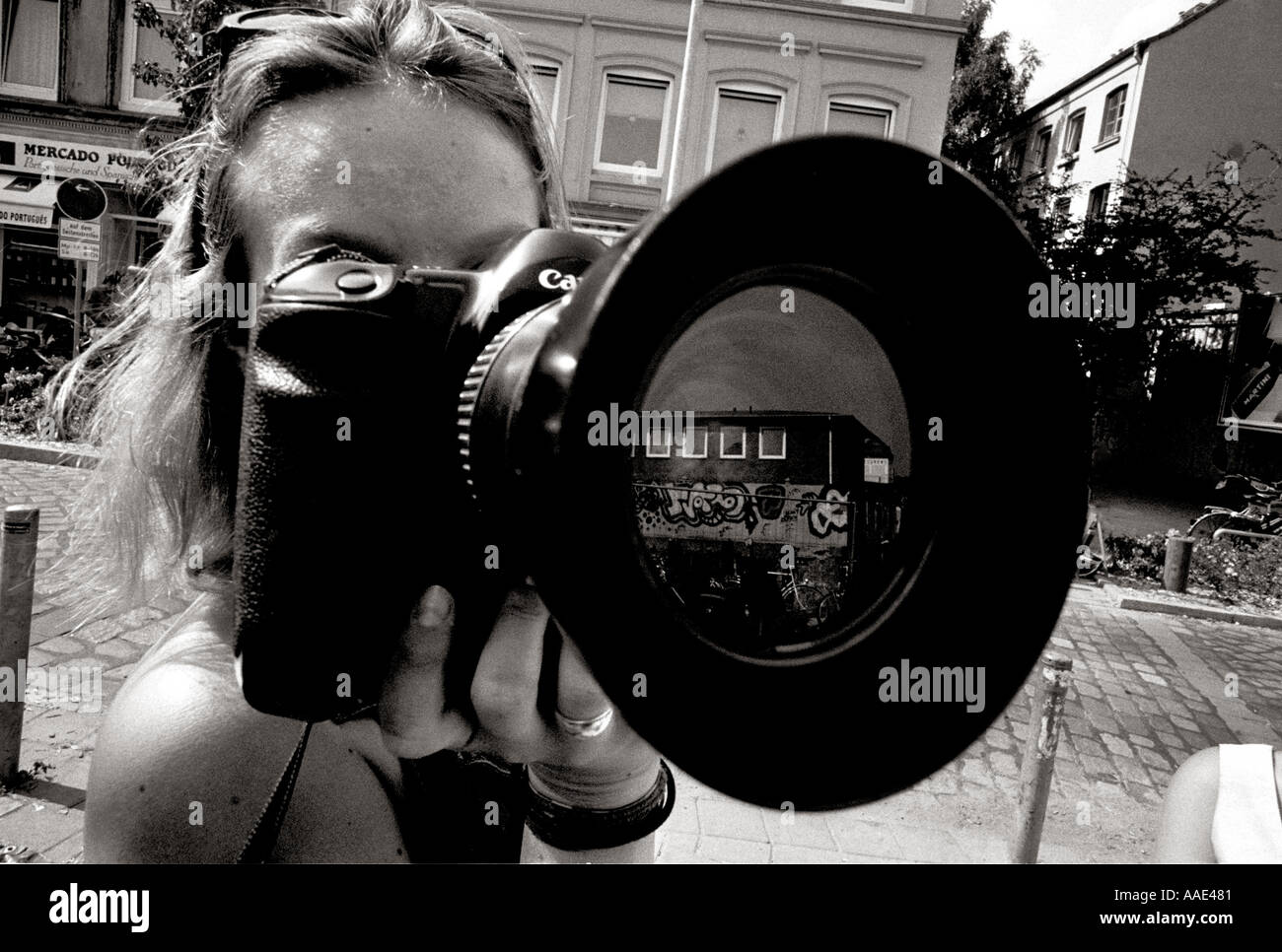 Big camera covering the face of a girl Stock Photo - Alamy